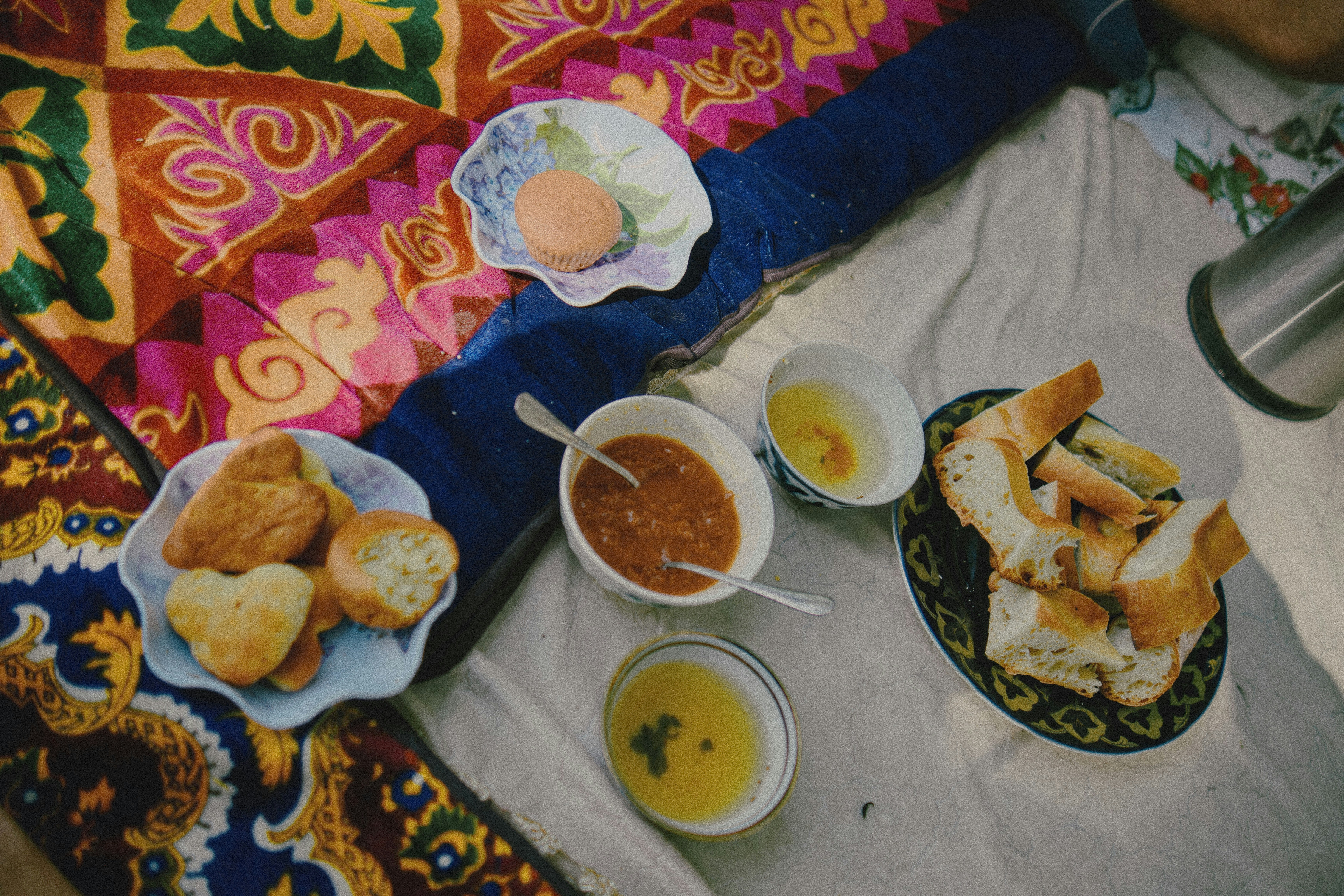 Colorful spread on a patterned cloth: a casual picnic snack setup