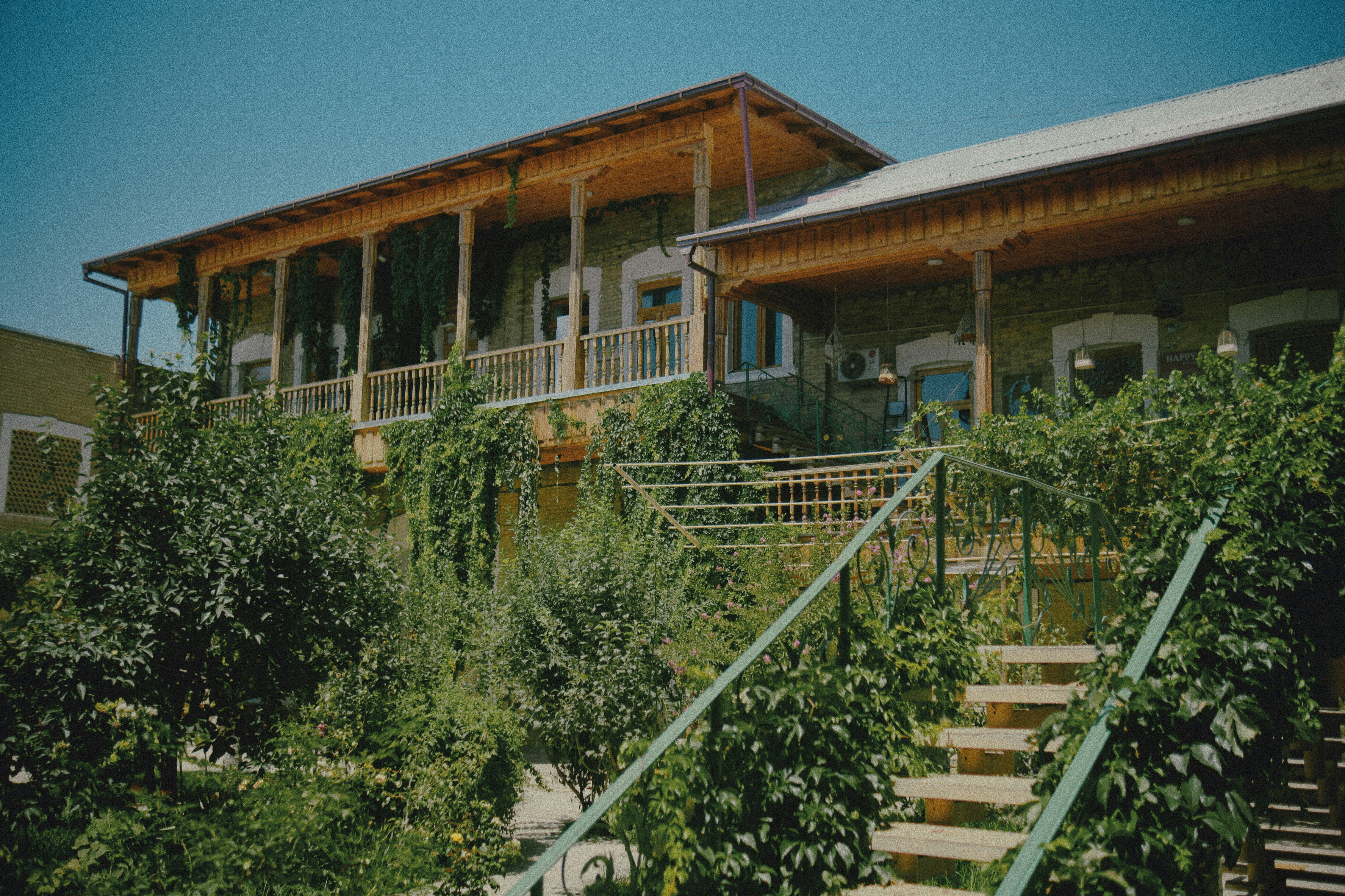 Overgrown Veranda: A Rustic Villa Framed by Greenery
