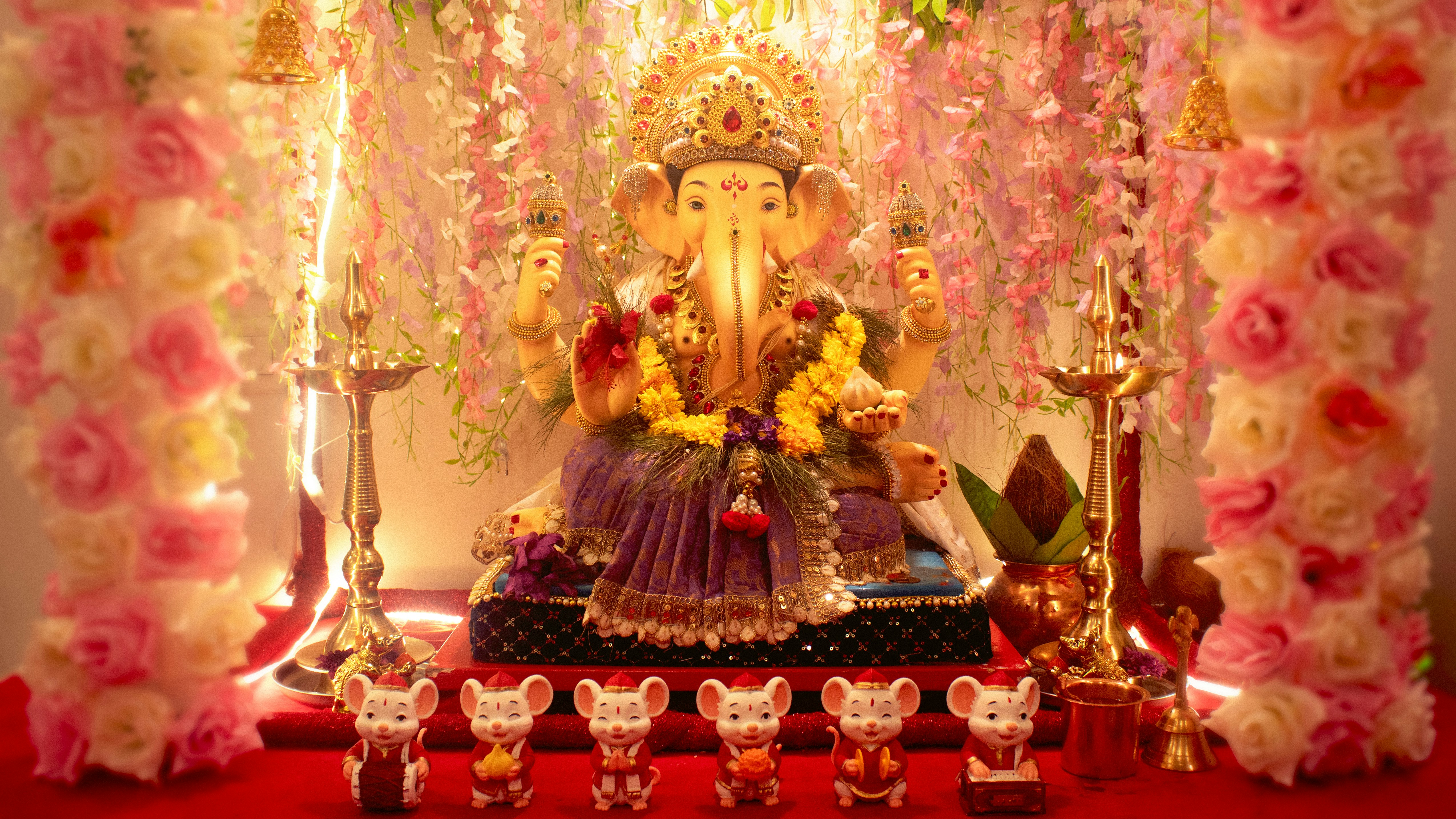 Ganesha Idol Adorned with Garlands in Floral Shrine