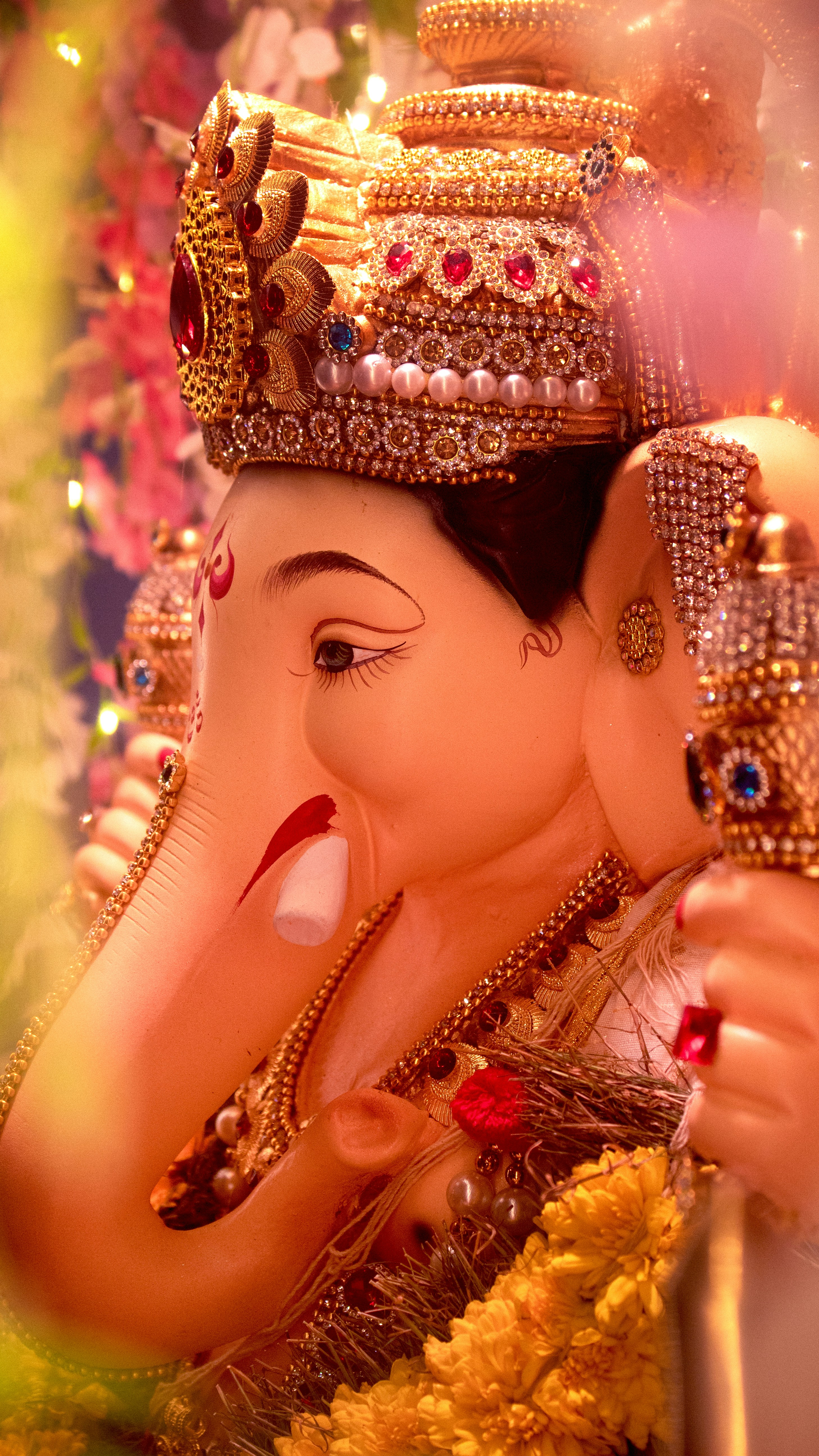 Sacred Ornament: A Bustling Ganesha Shrine in Glassy Amber