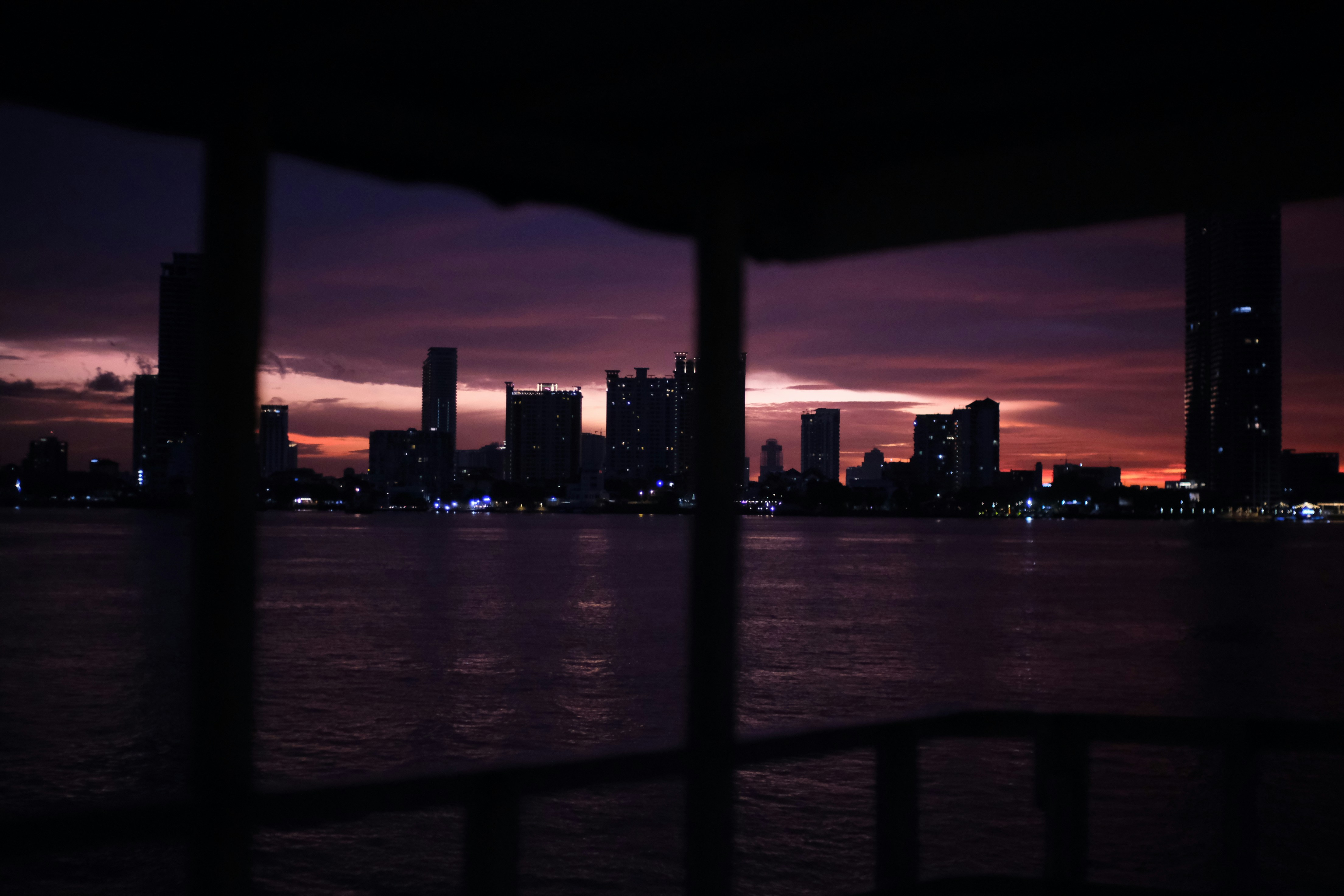 Evening Skyline Through a Waterfront Window