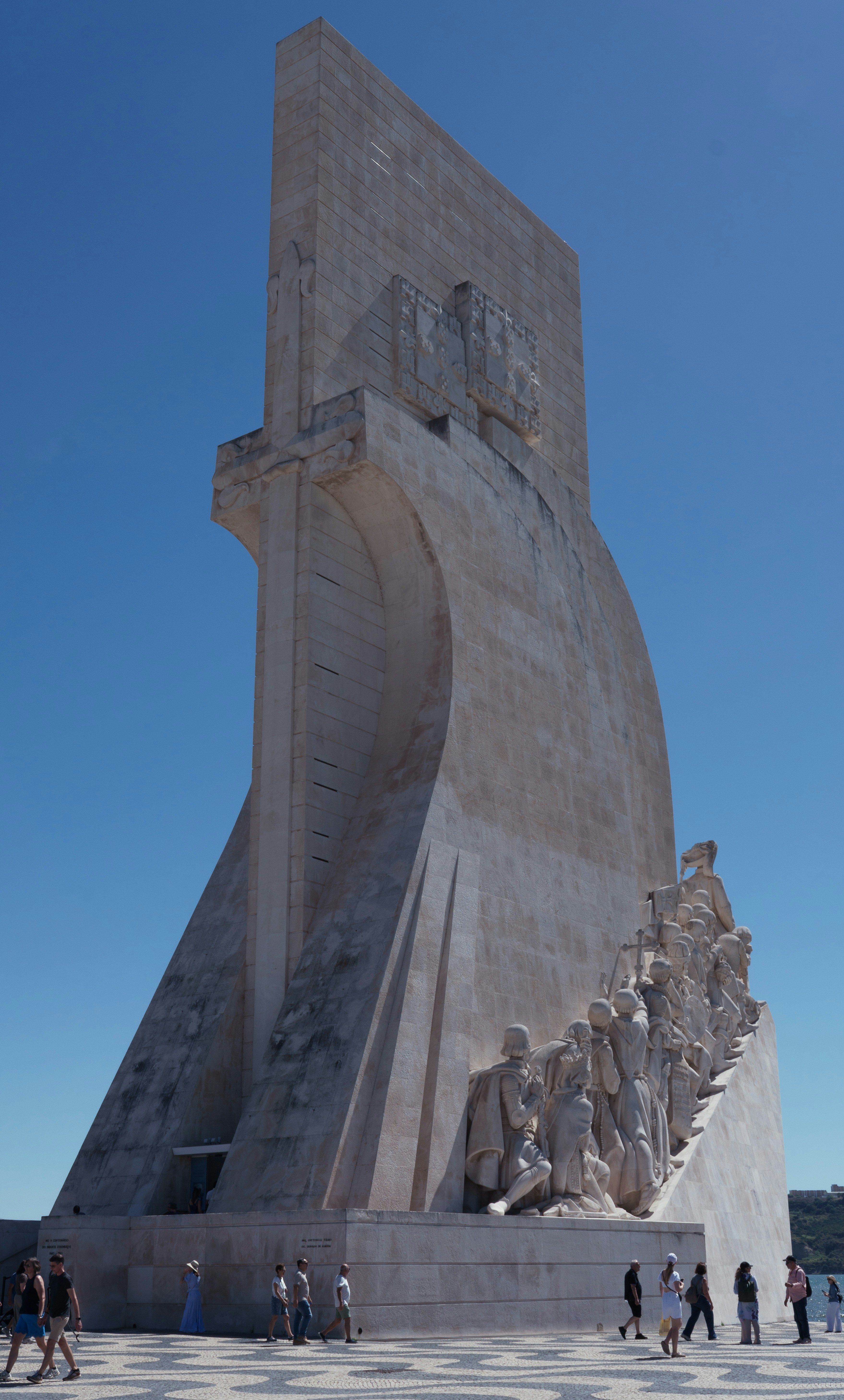 Monumental Ascent: Sculpted Figures Guard the Arching Tower