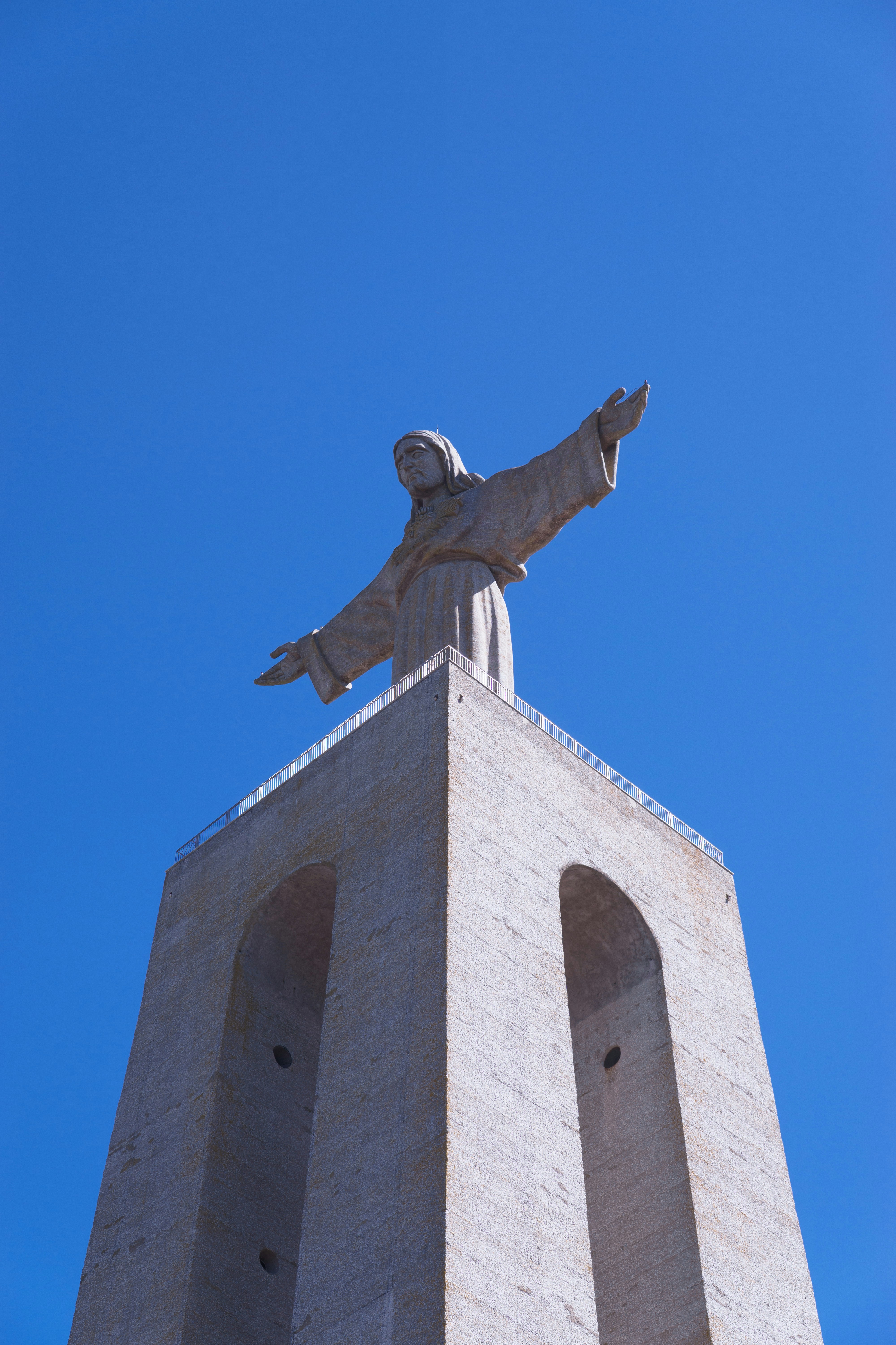 Colossal Reach: Statue of Liberty-like Figure Standing Above a Prism of Stone