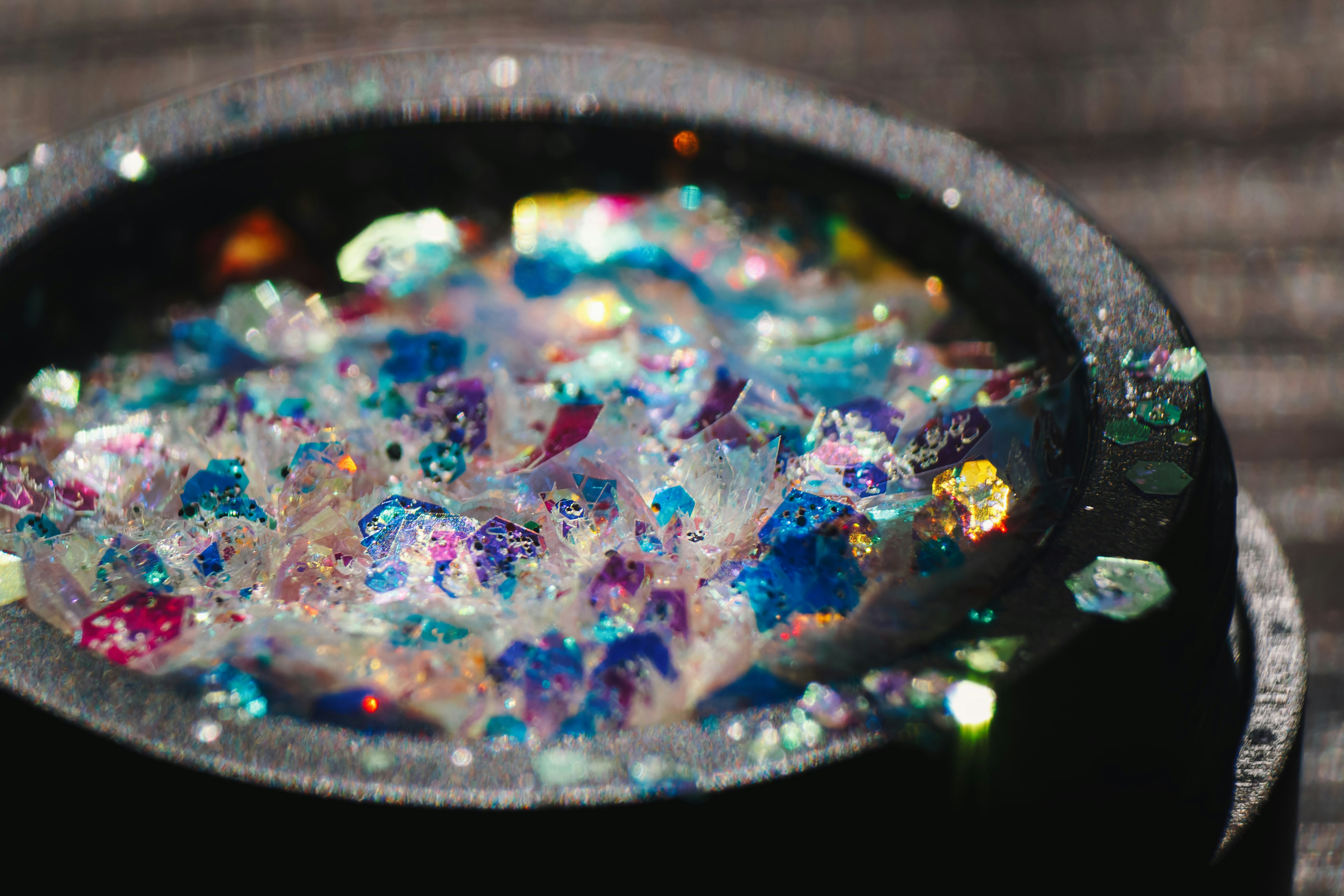 Gemstone mosaic under a ring of light: a macro glow of shattered crystals
