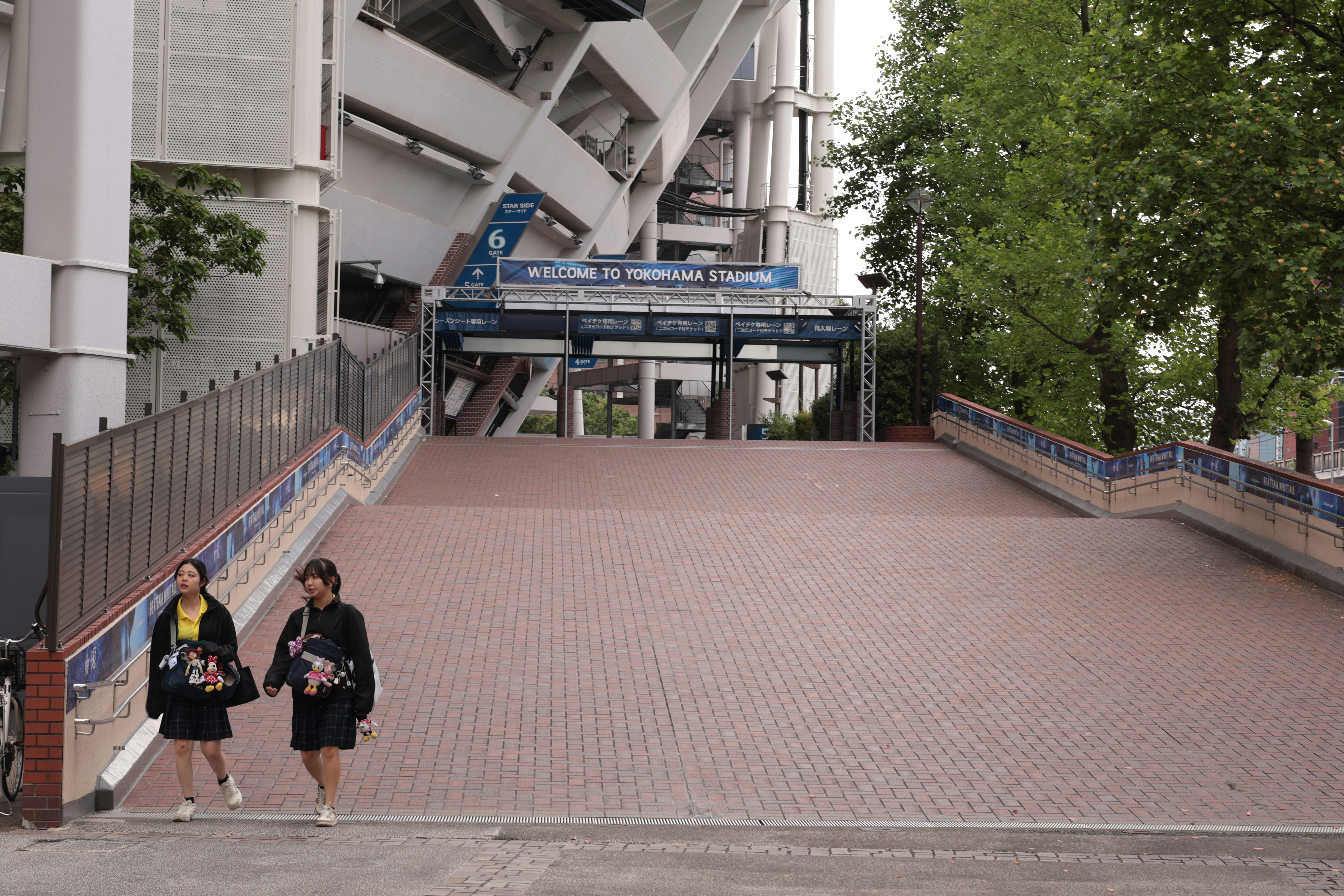 Escalator Gate to the Stadium: Two Fans Step Toward Entry
