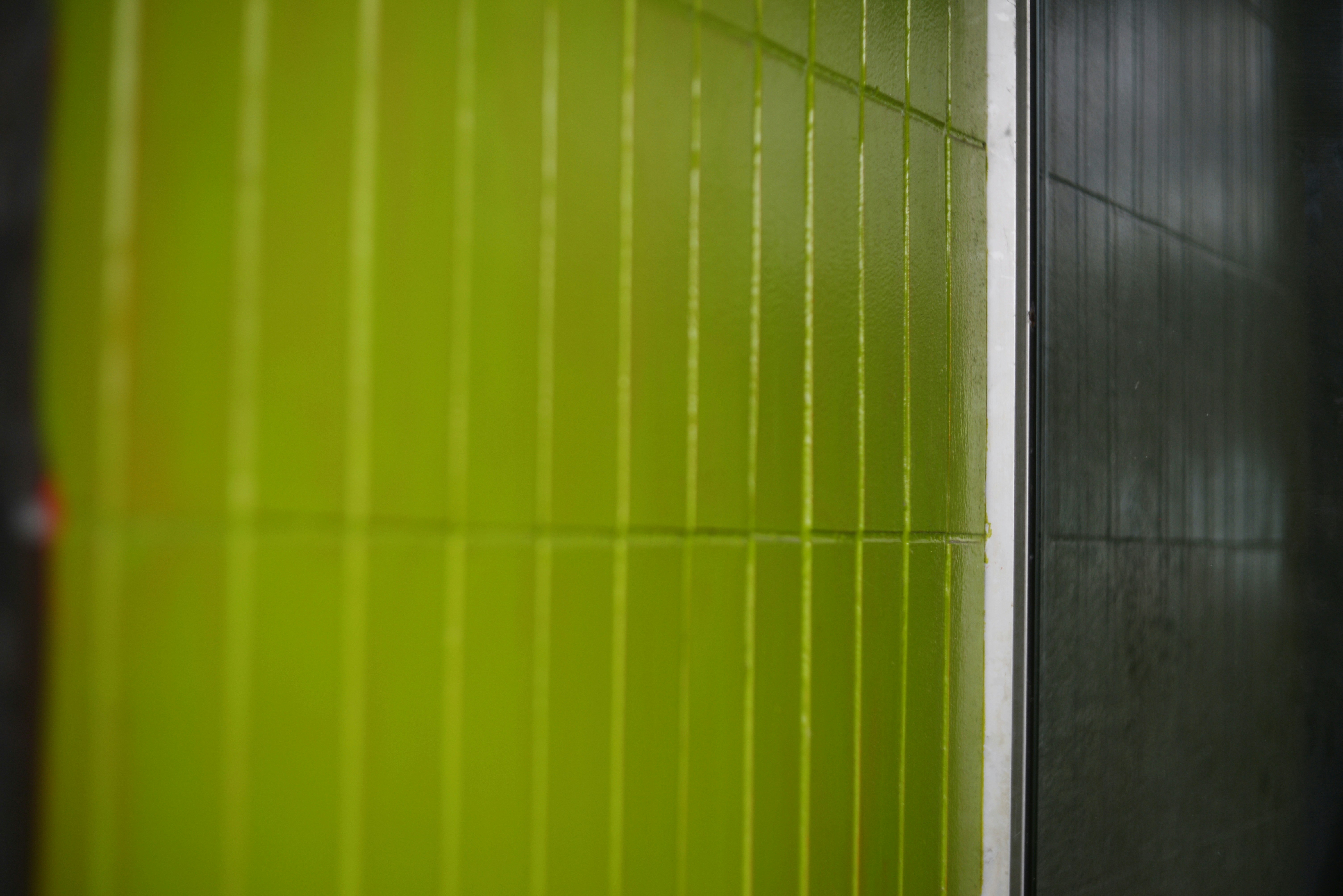 Neon-green Tiles and Dark Edge: A Quiet Subway Corner