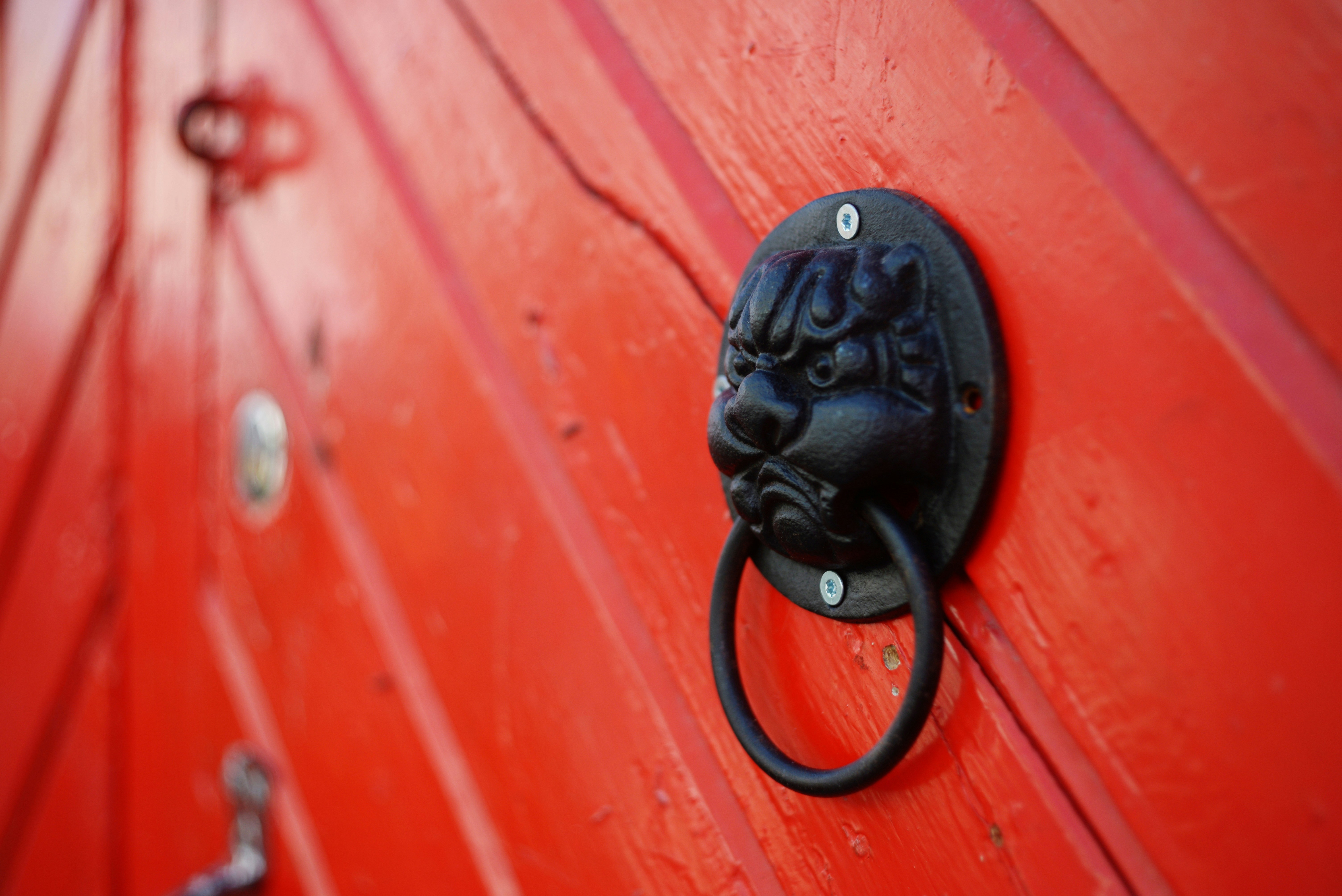 Ringed Door Knock on a Fiery Red Gate