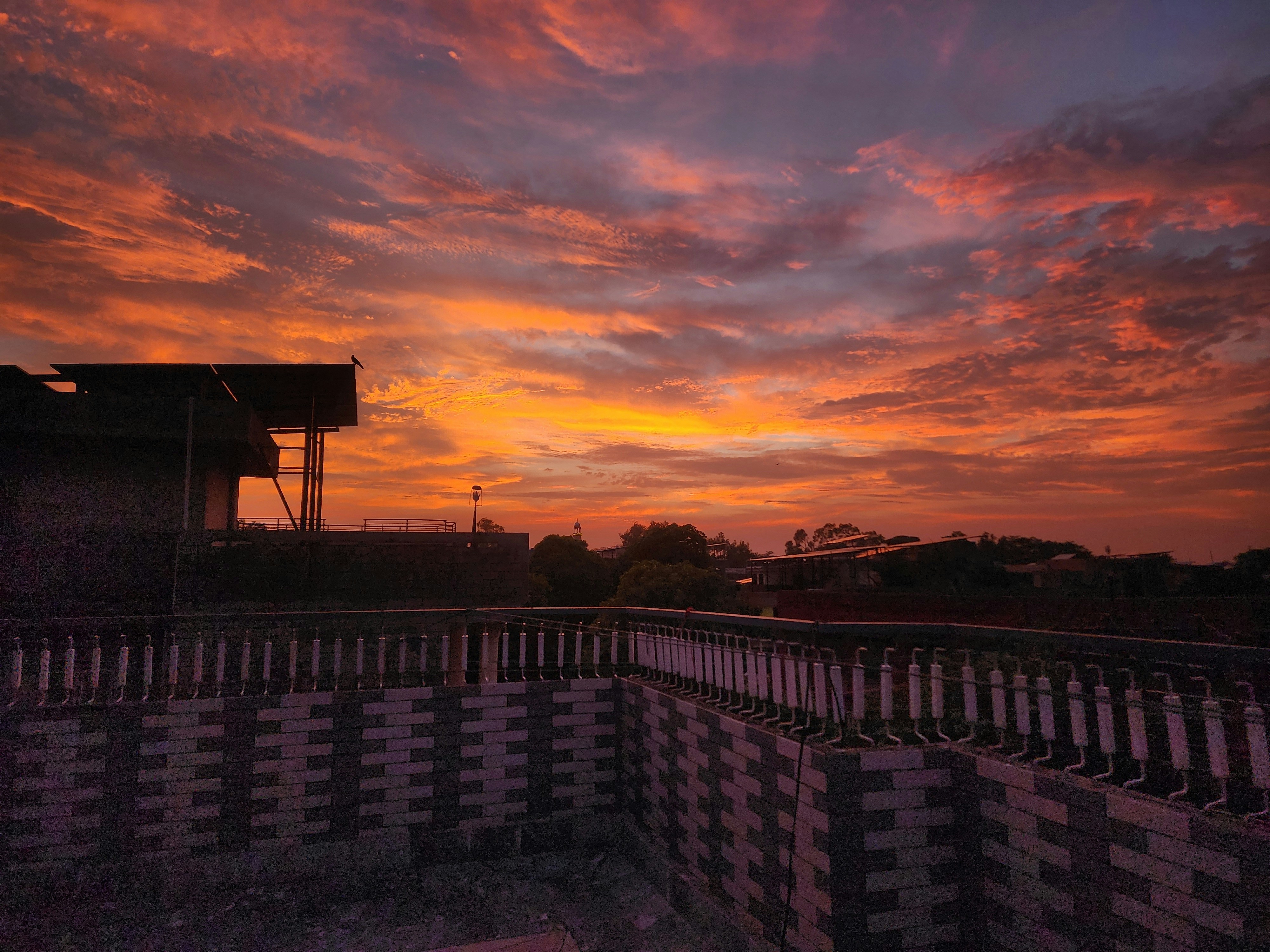 Sunset Terrace: Brick Balustrades Framing a Fiery Sky