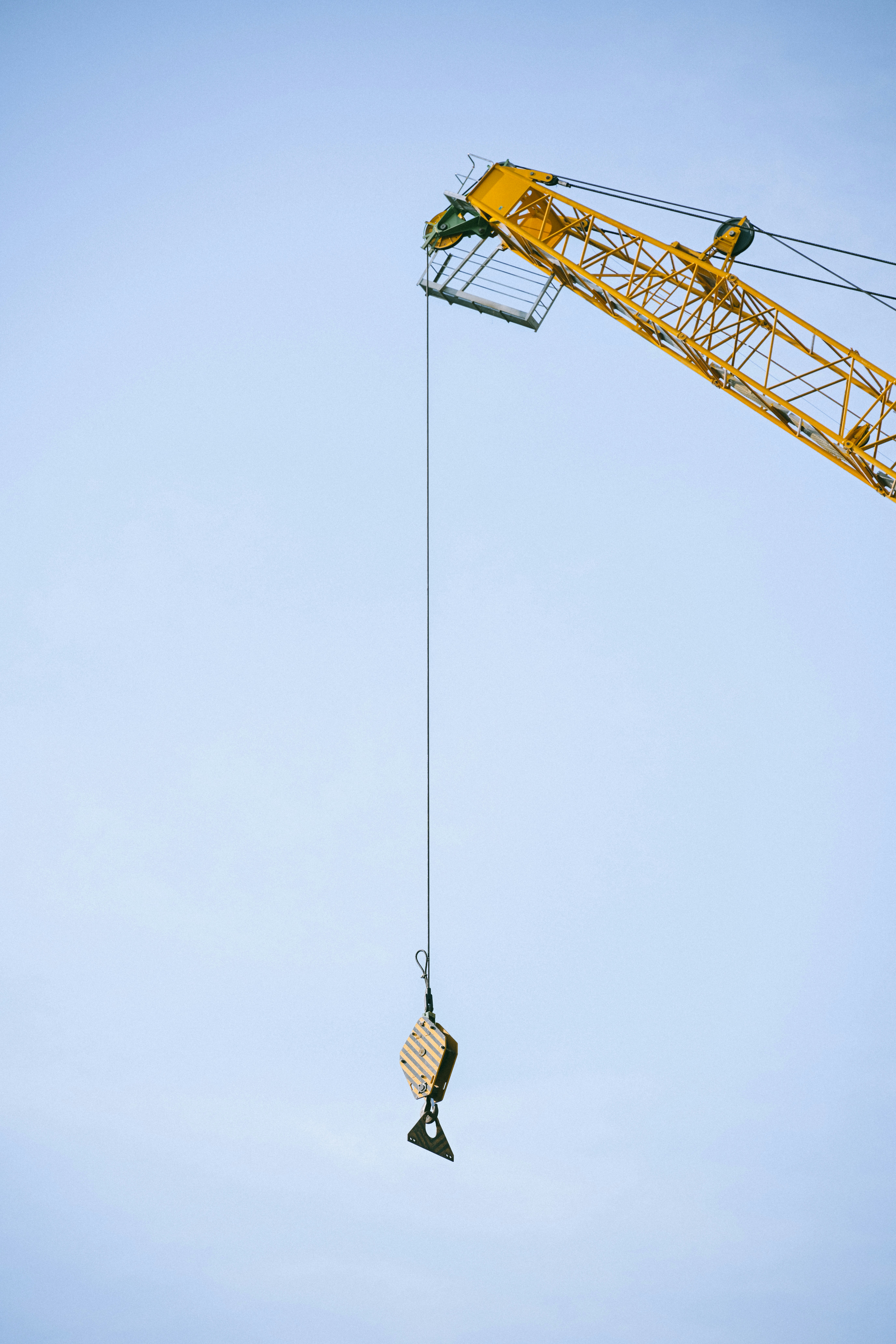 Tower Crane Lift: The Suspended Pallet Against a Clear Sky