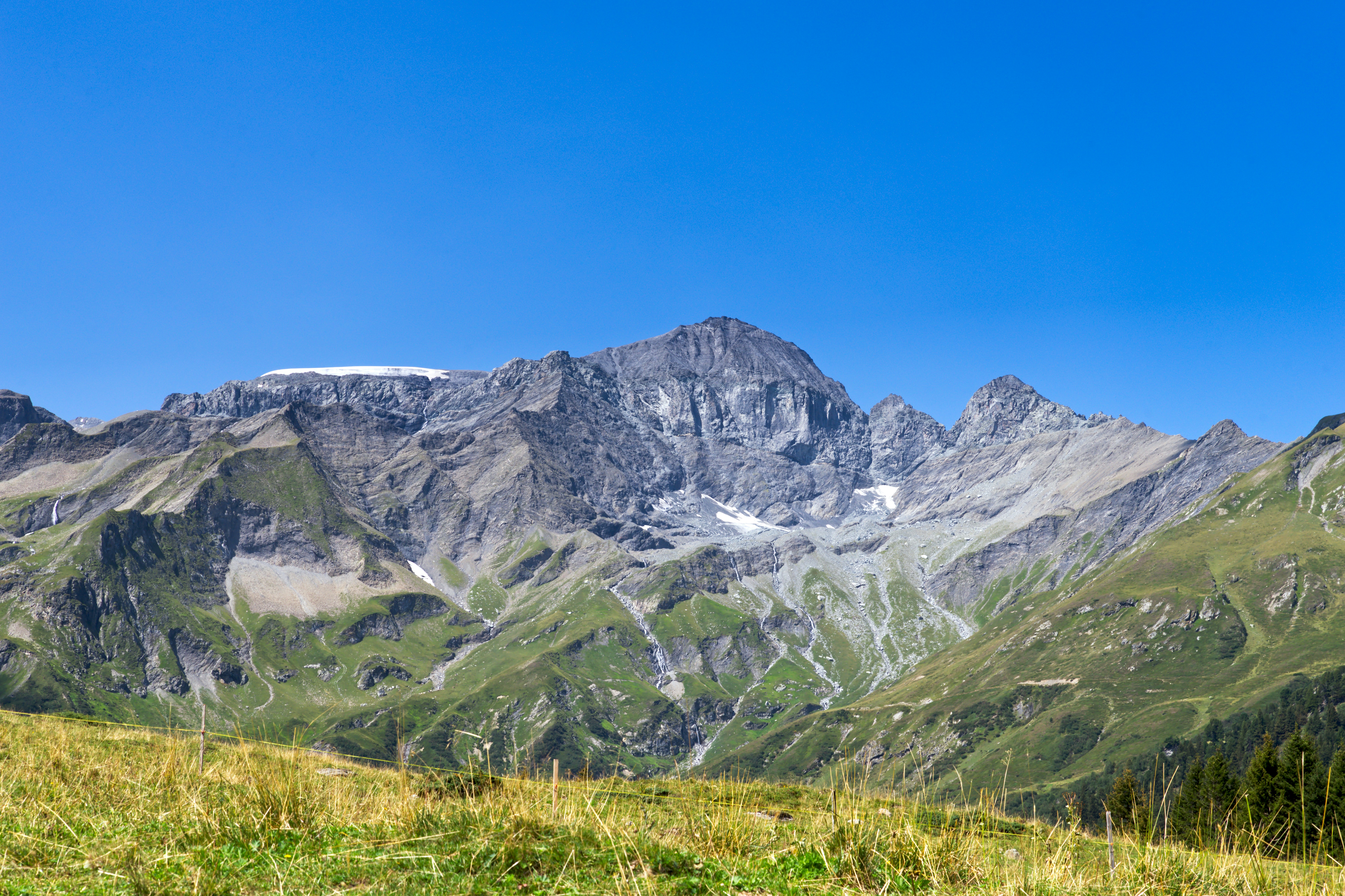 Snow-capped ridge beneath a pristine alpine sky