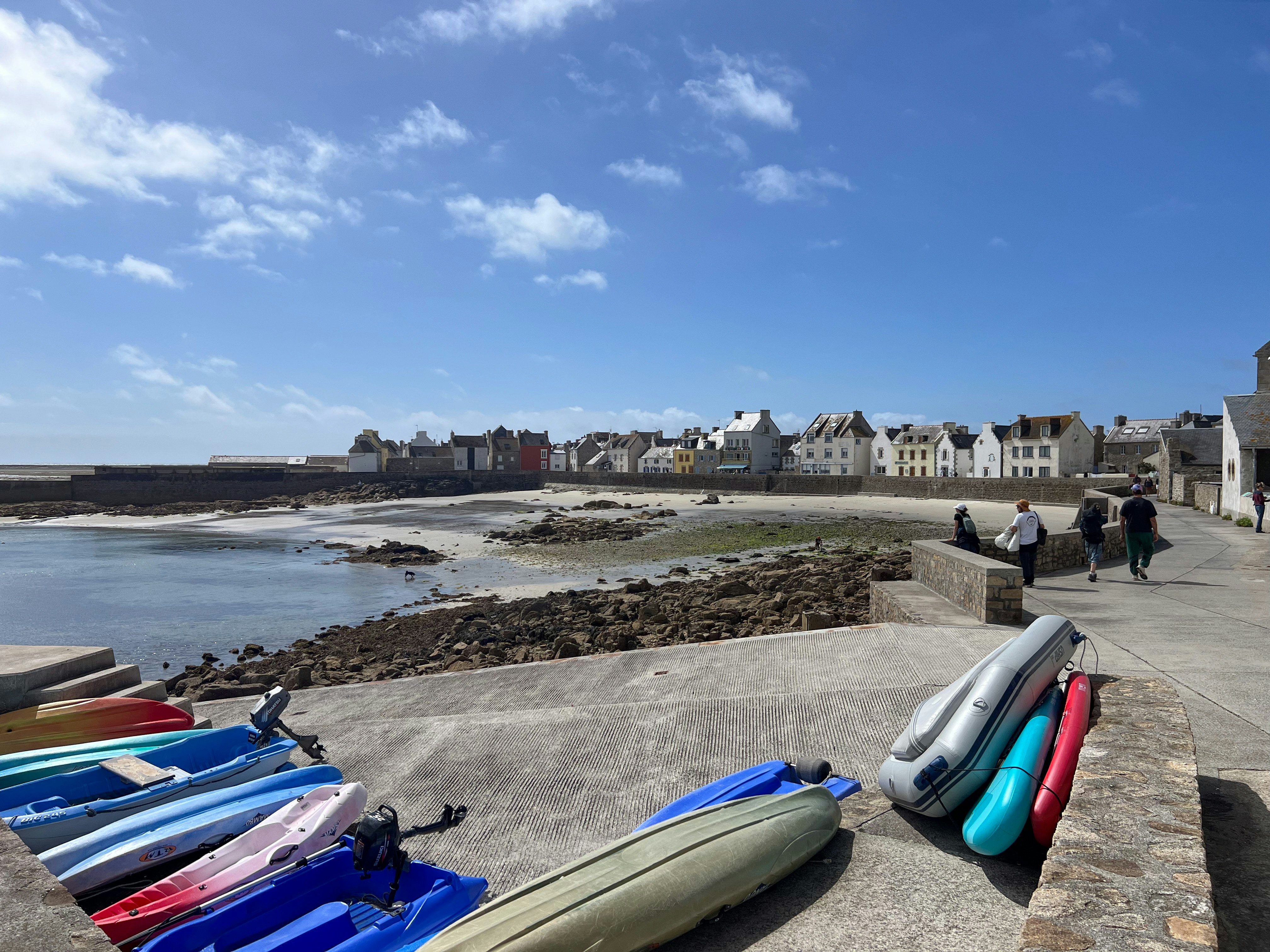 Coastal Boats Rest Along a Historic Harbor Walk