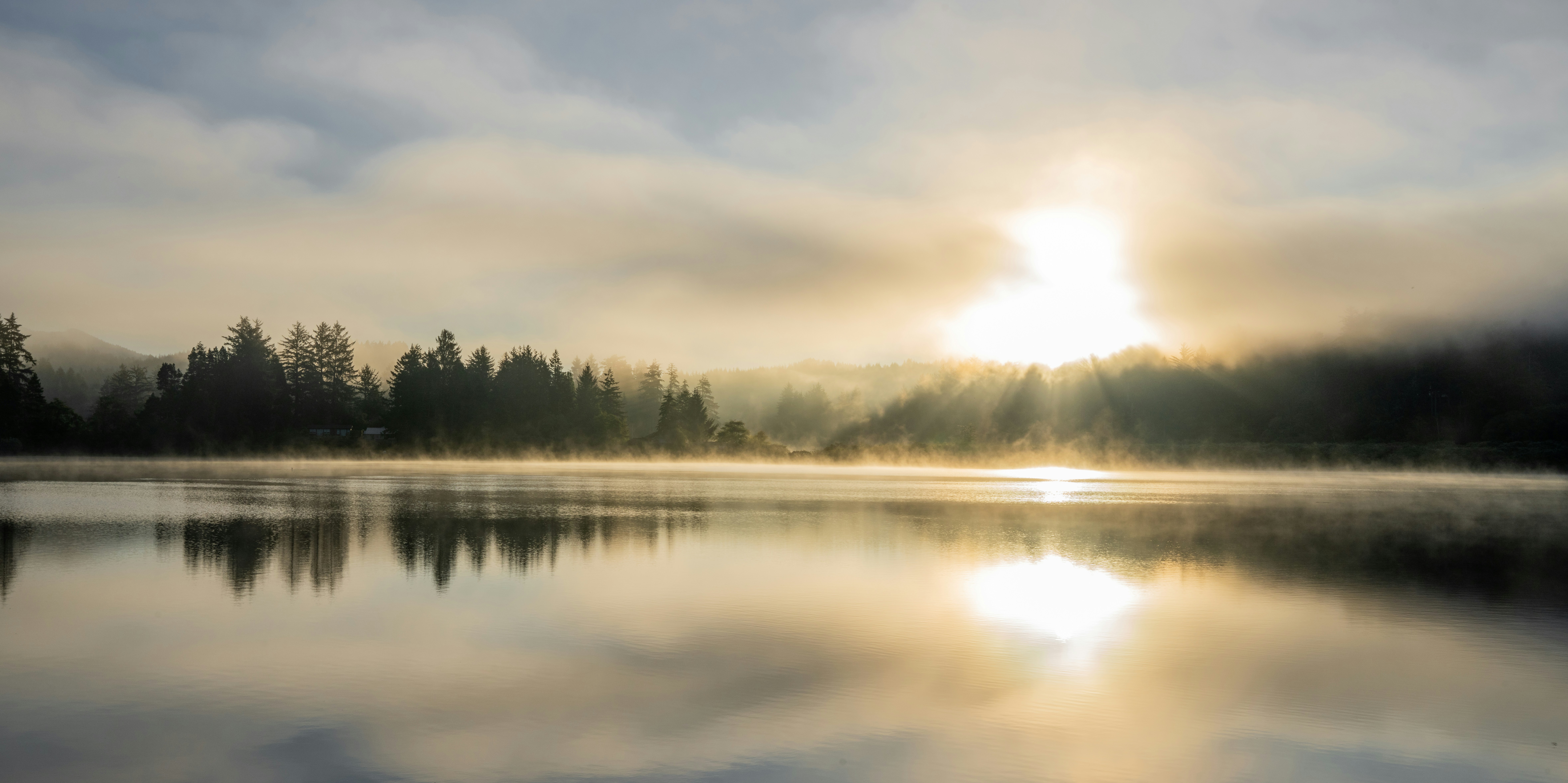 Echoes on the Lake: Dawn Mist Over a Quiet Horizon