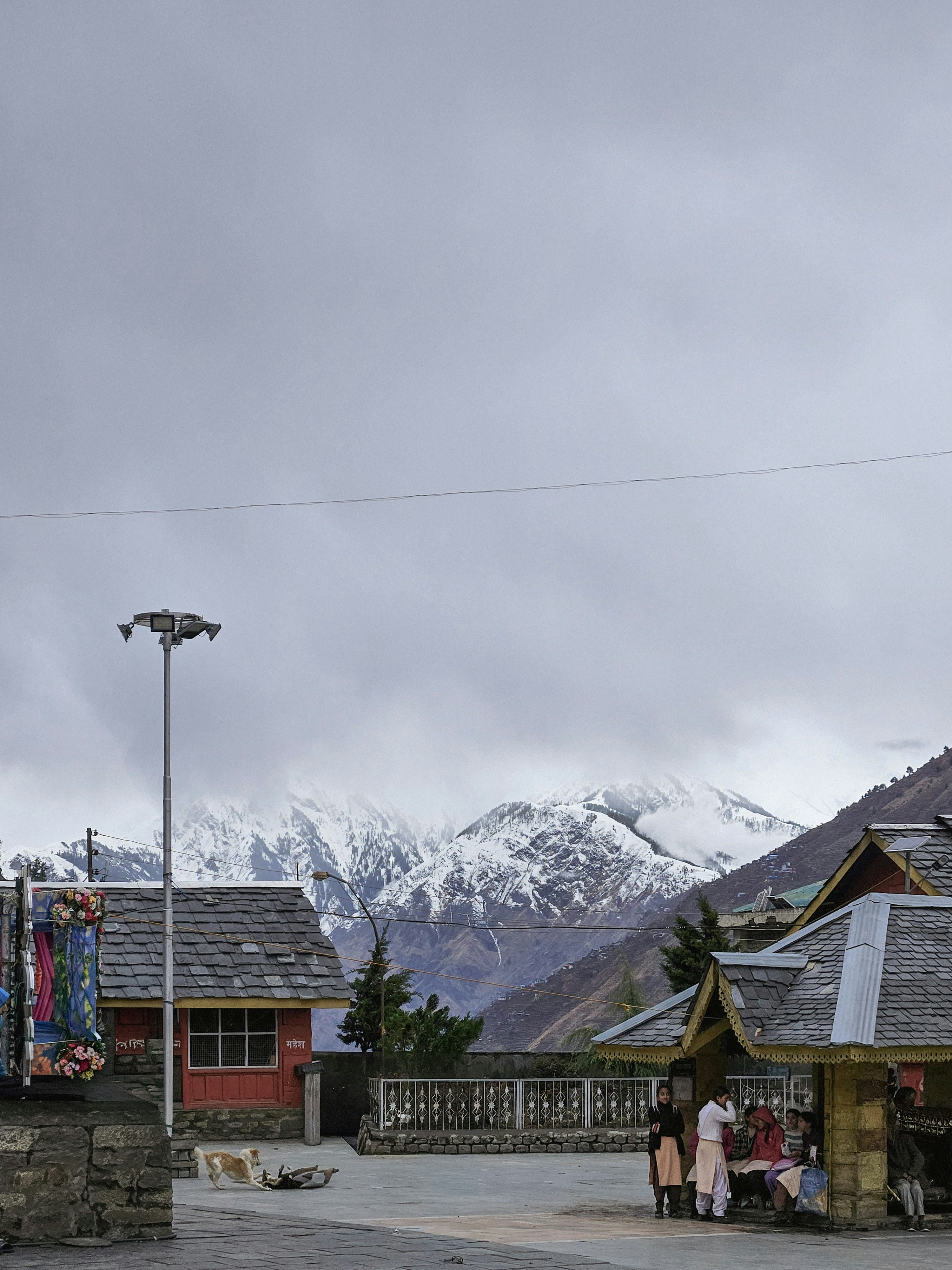 Snow-kissed Peaks Over a Quiet Village Square