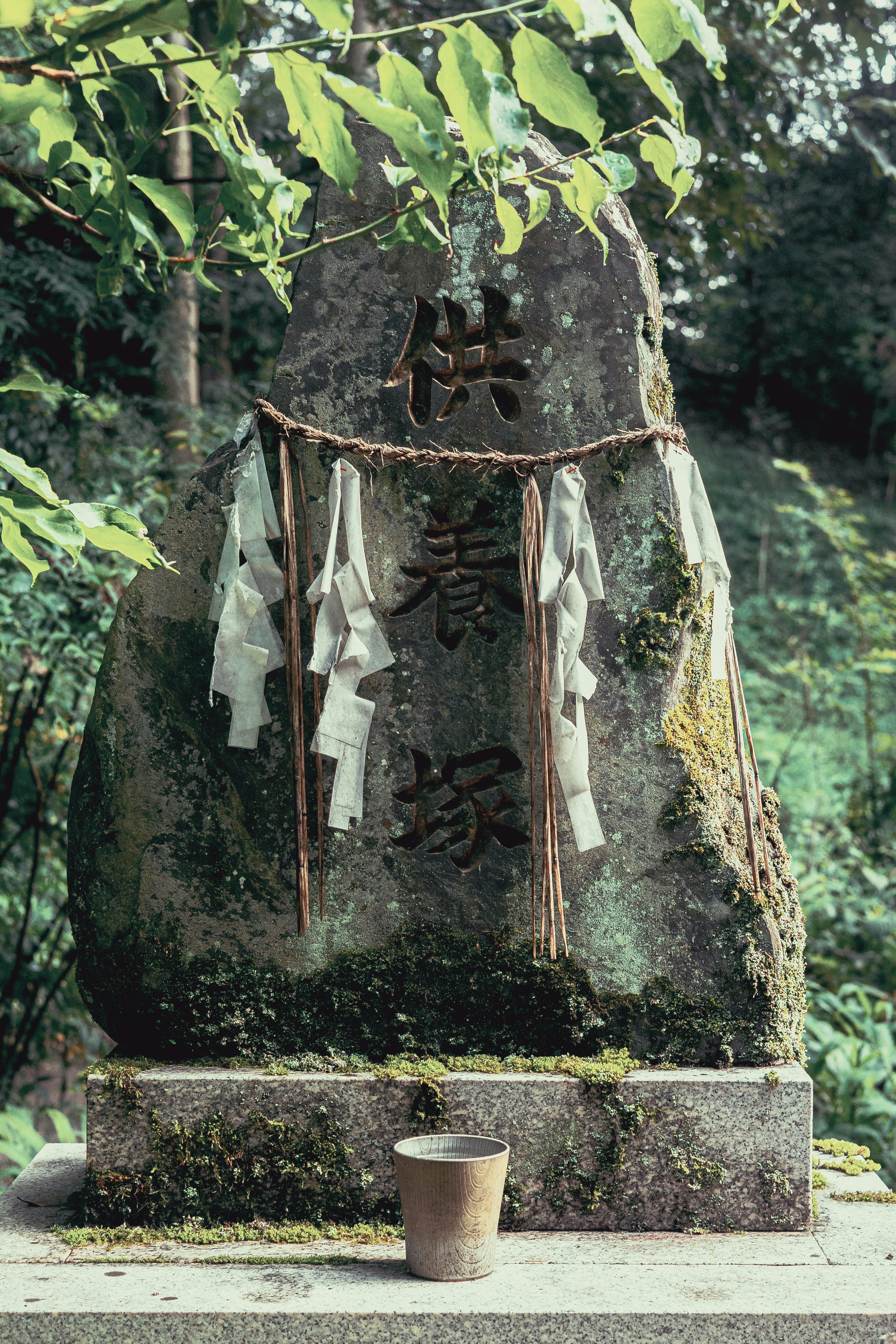 Sacred Stone: Shimenawa and Paper Strips Guard a Quiet Shrine