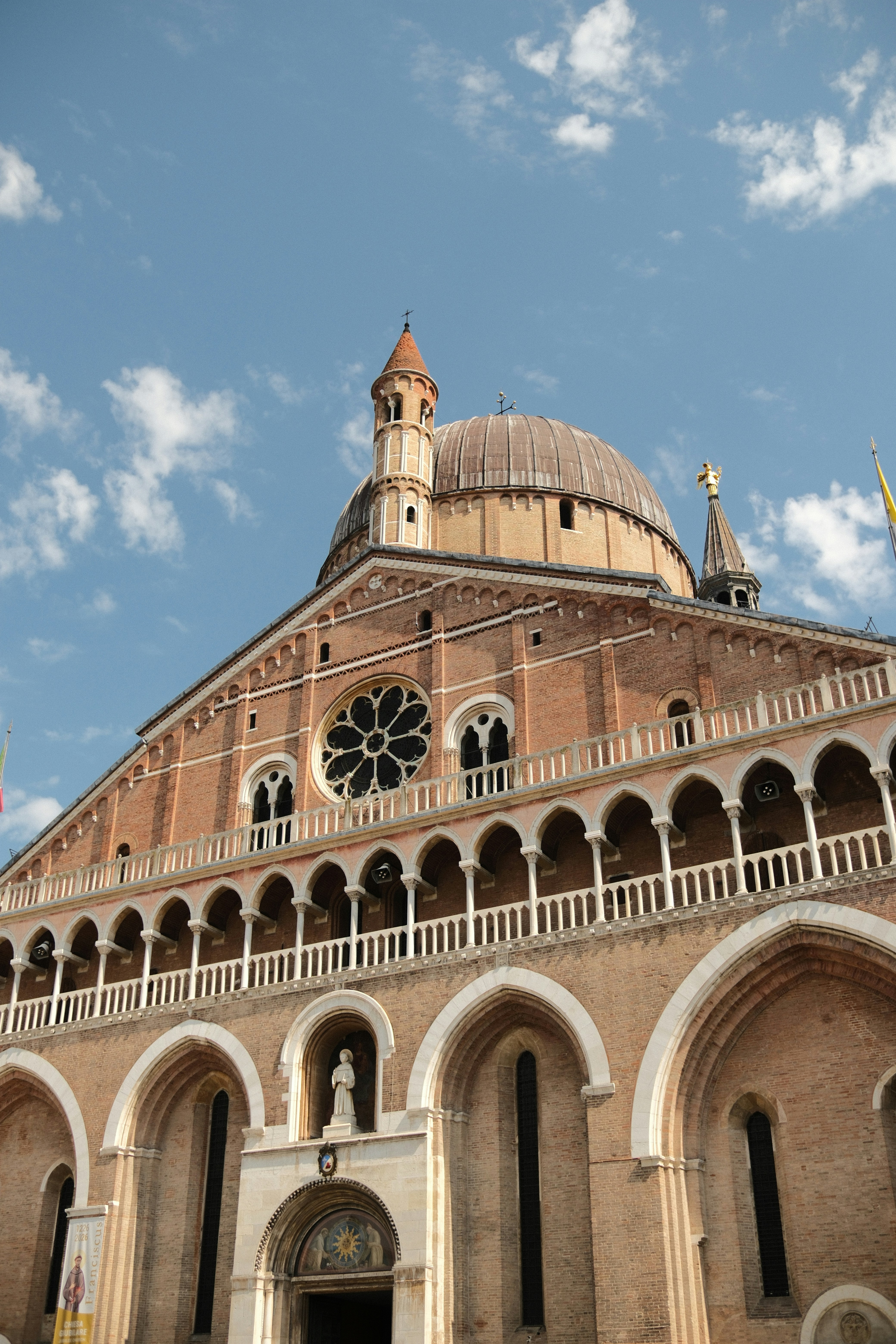 Brick Arches and Dome Rise: A Cathedral Facade Under Blue Sky
