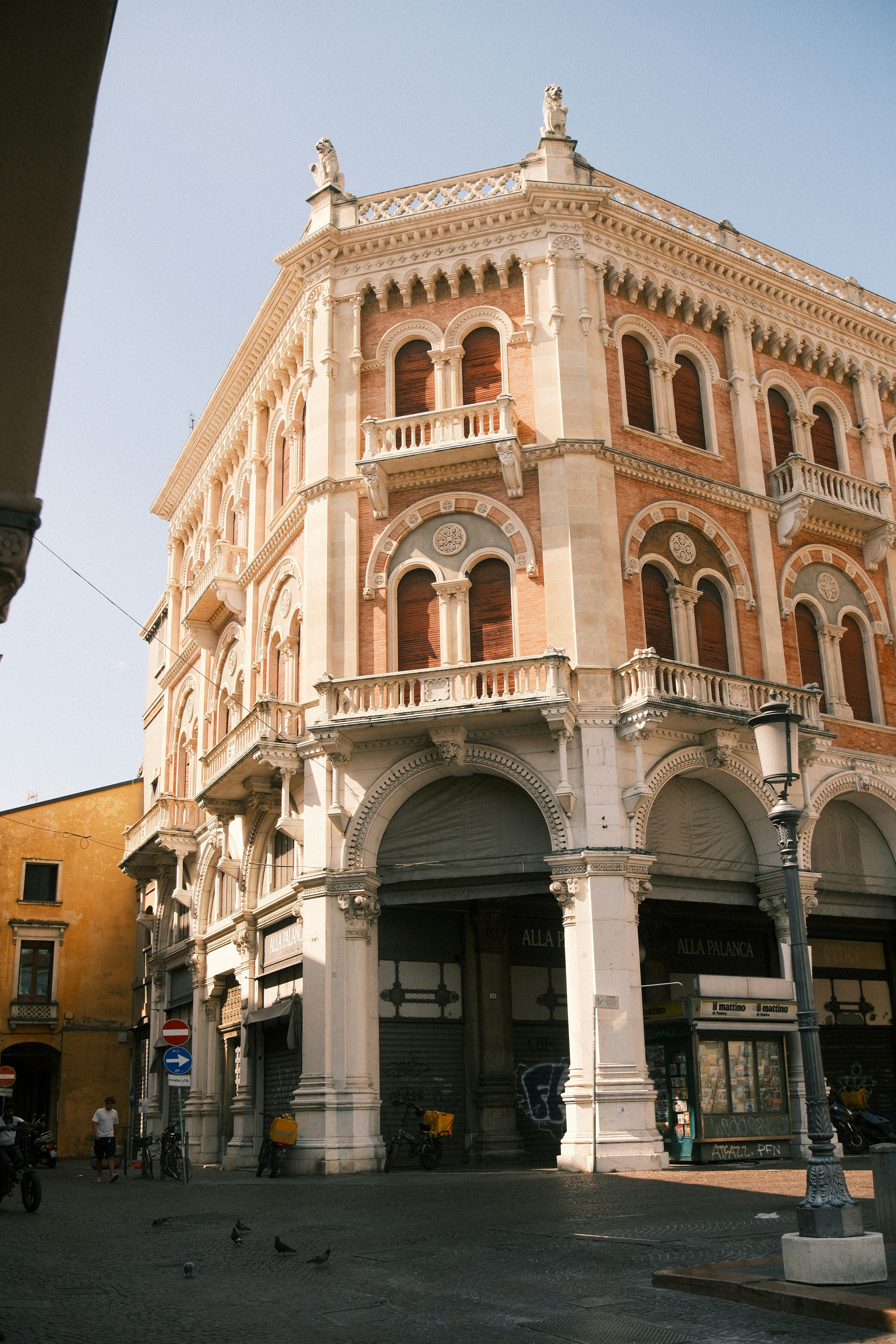 Heritage Archways: A Sunlit Corner Facade in Warm Italian Light