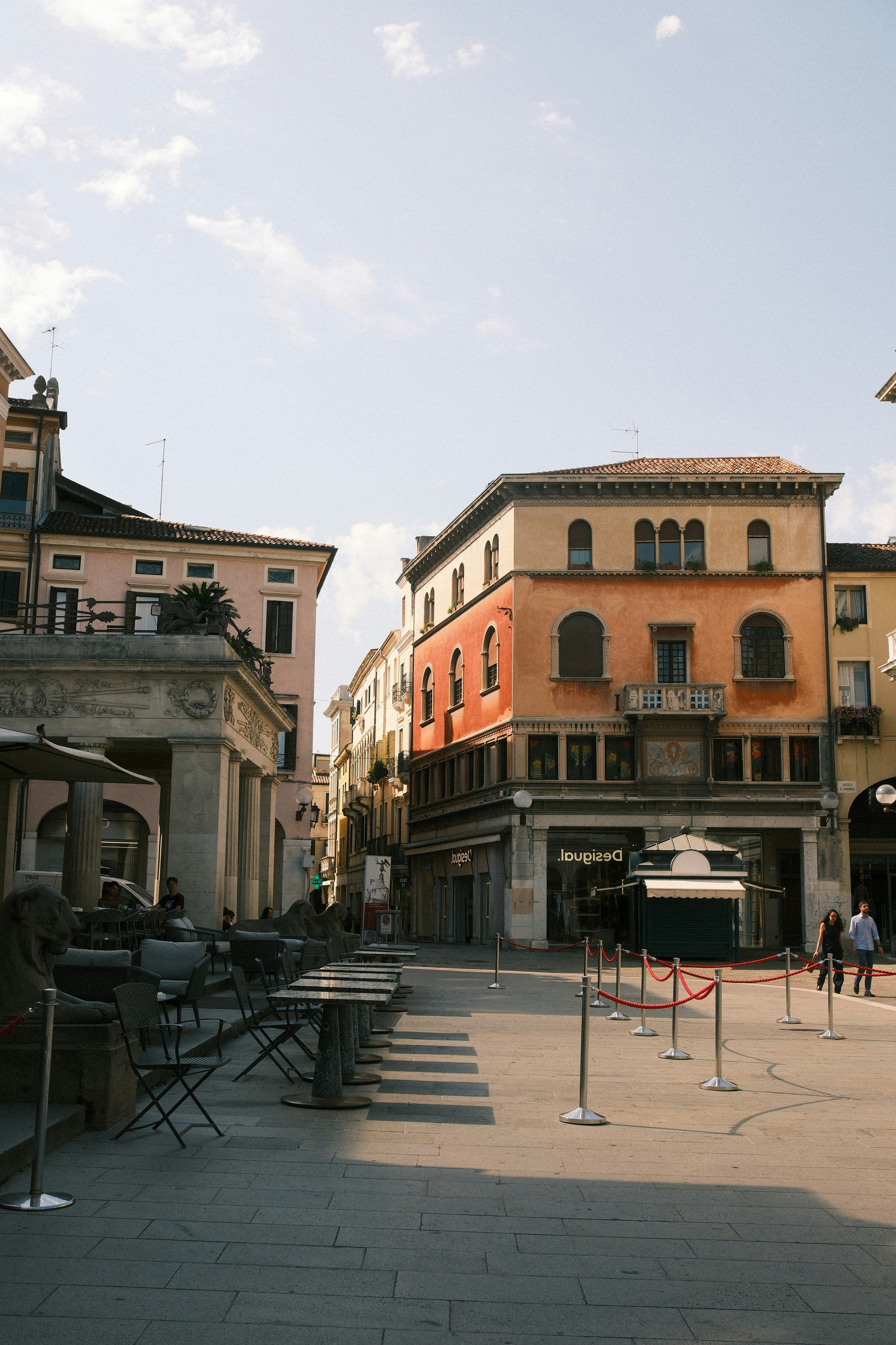 European plaza at golden hour: warm tones and quiet storefronts
