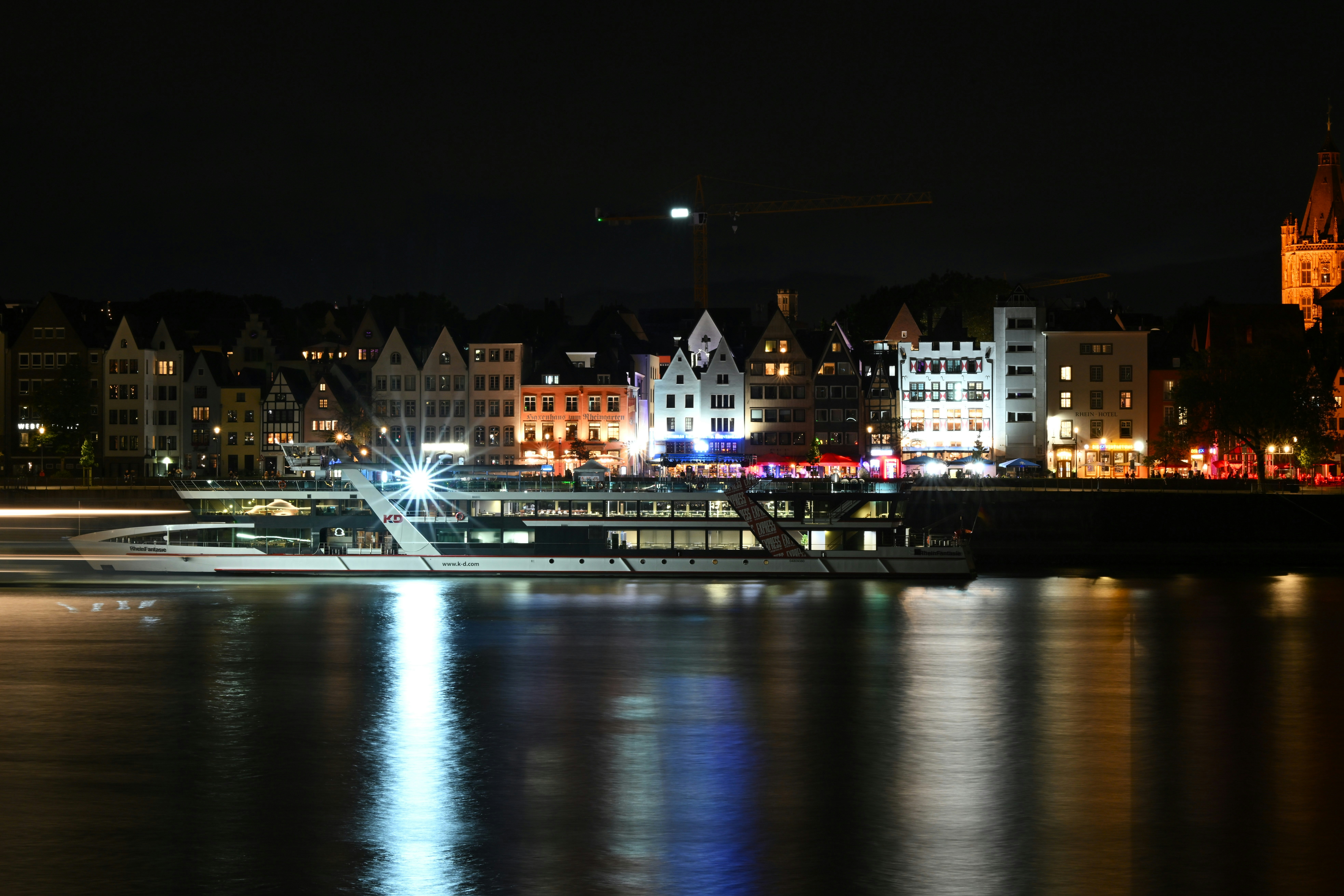 Night Riverfront: Neon Reflections on Quiet Waters