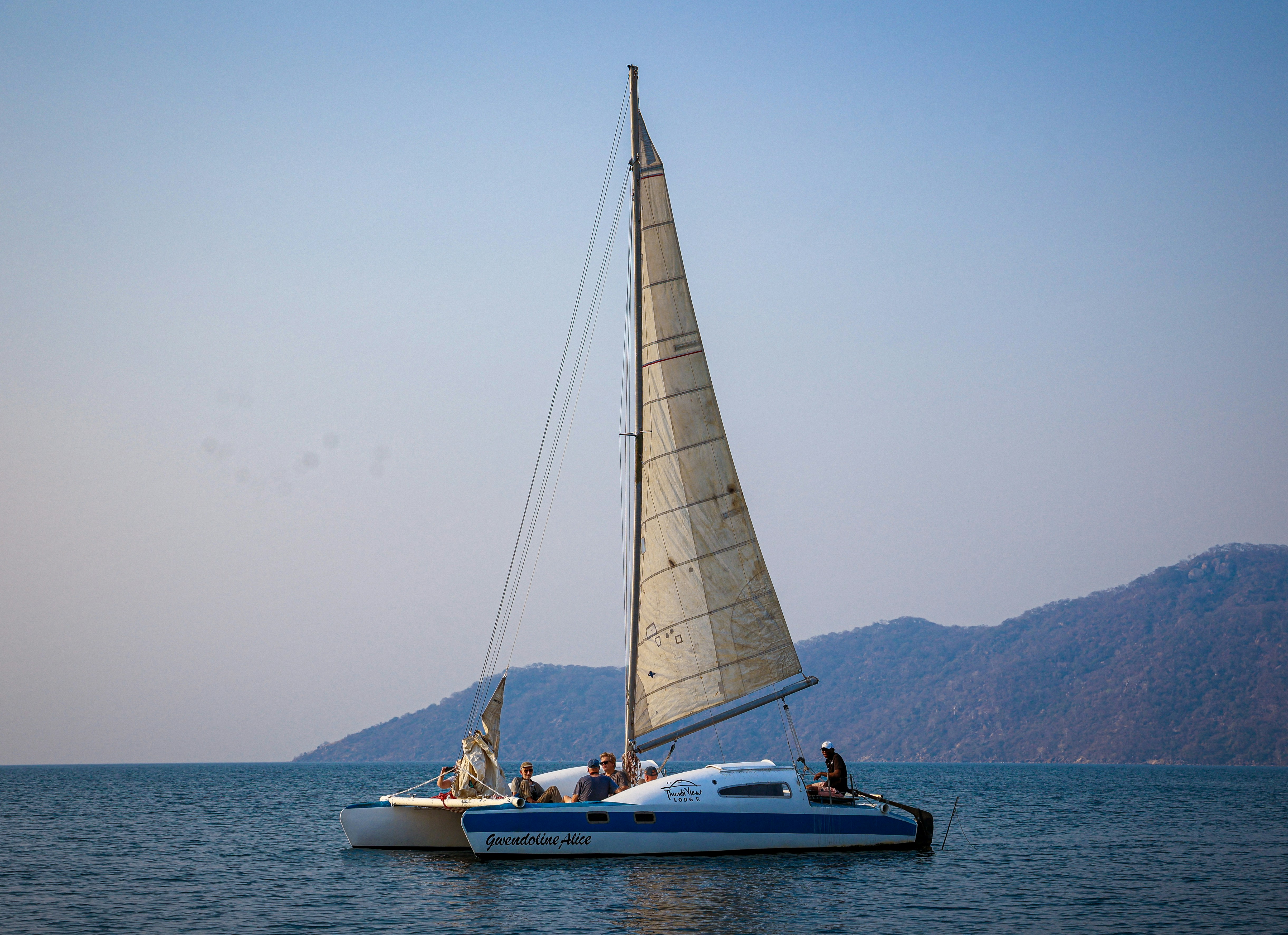 Sailing Unity: A Catamaran Glides under a Quiet Horizon