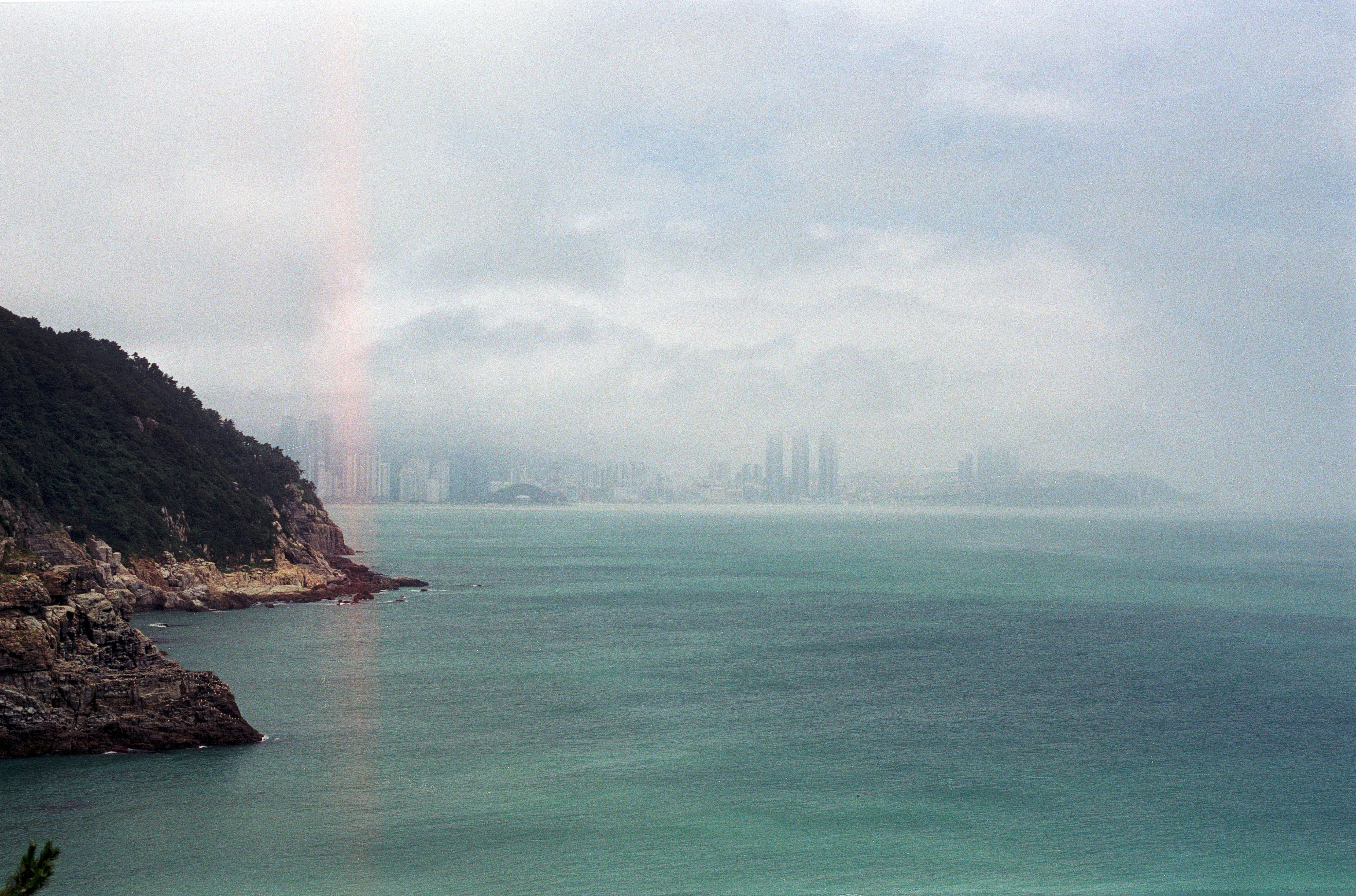 Coastal Ridge and Mist: A Quiet Horizon Over the Sea