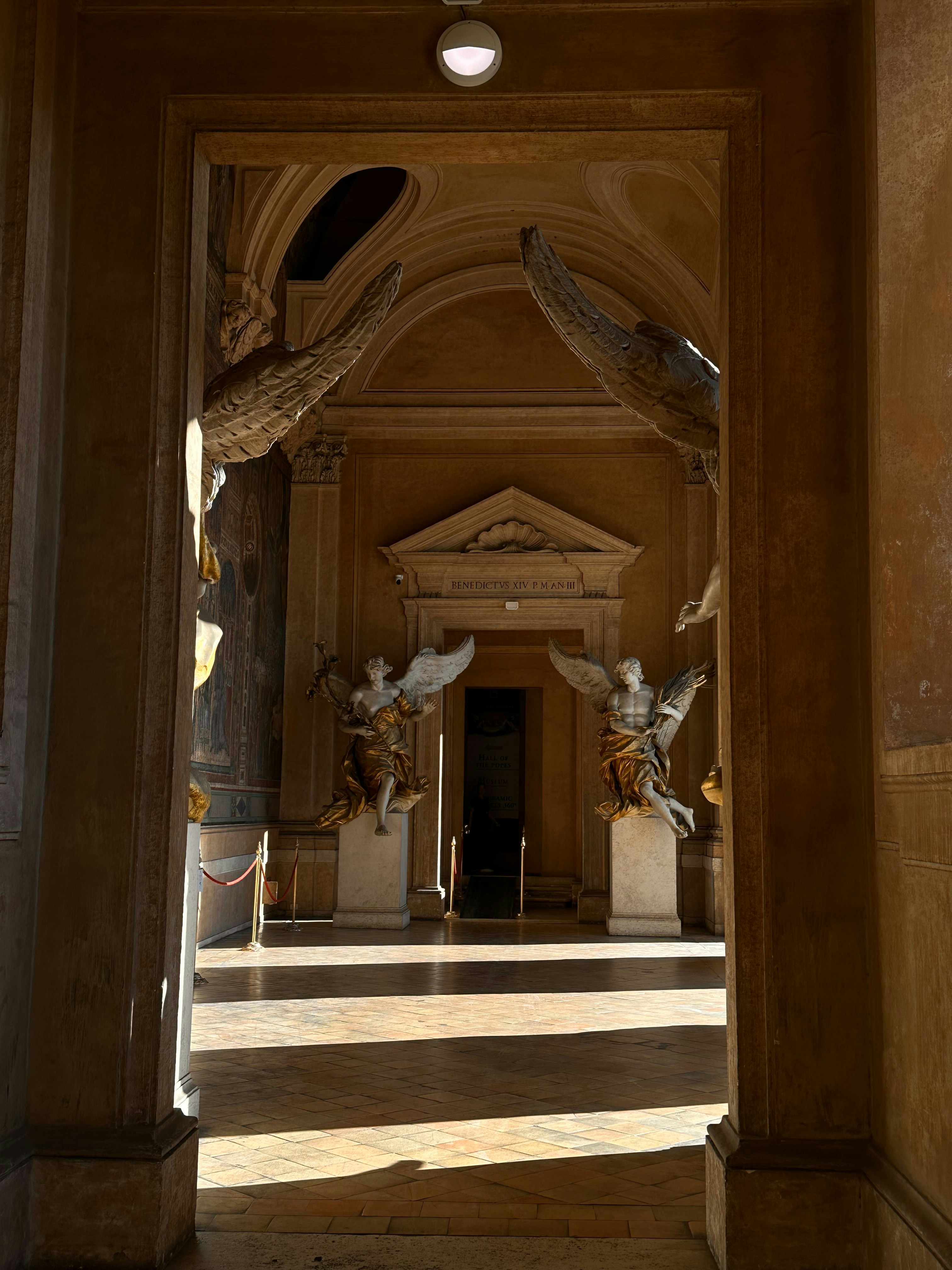Winged Guardians Over a Marble Corridor
