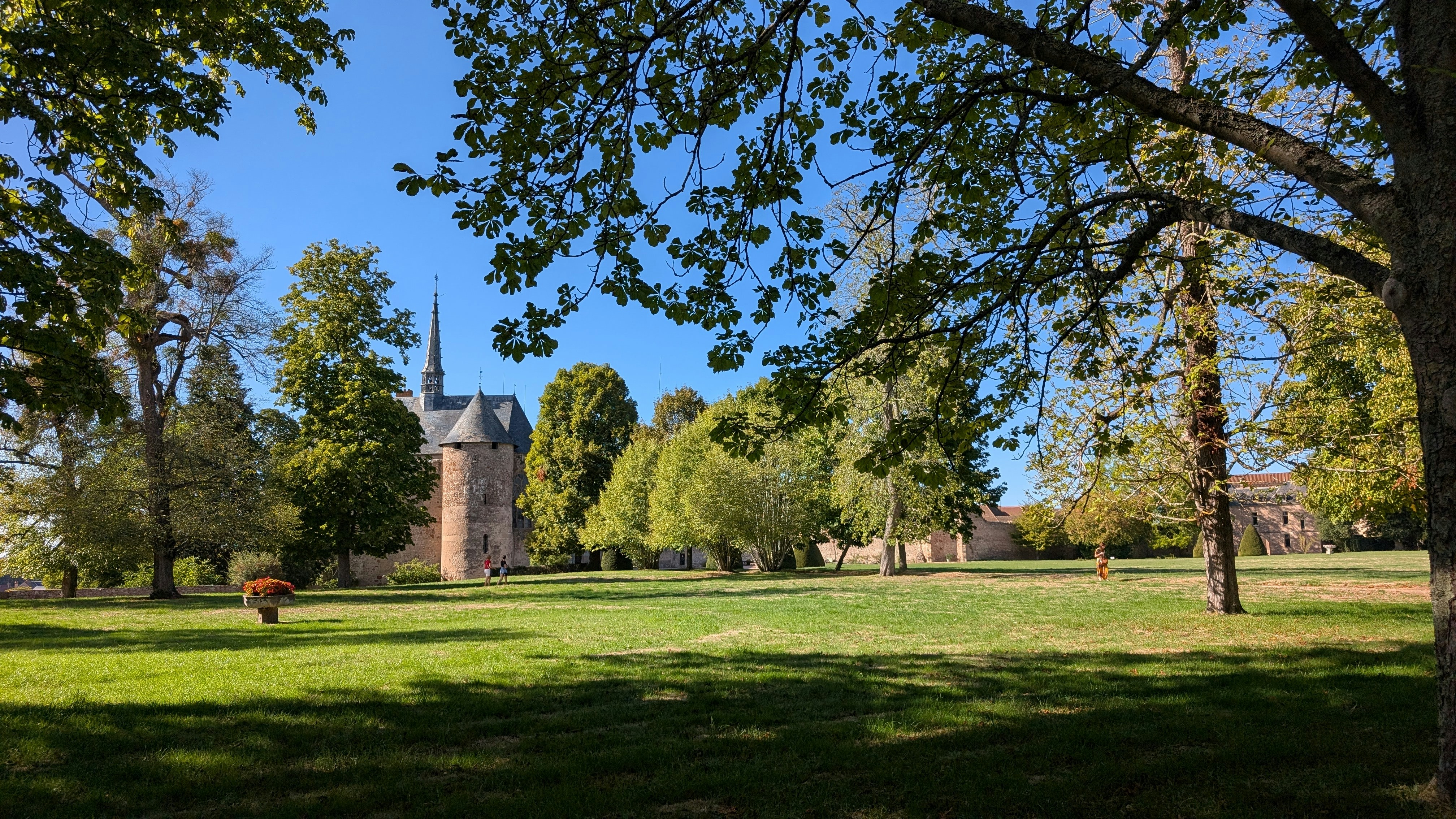 Sunlit Castle Island: A Quiet Park with Tower in the Distance
