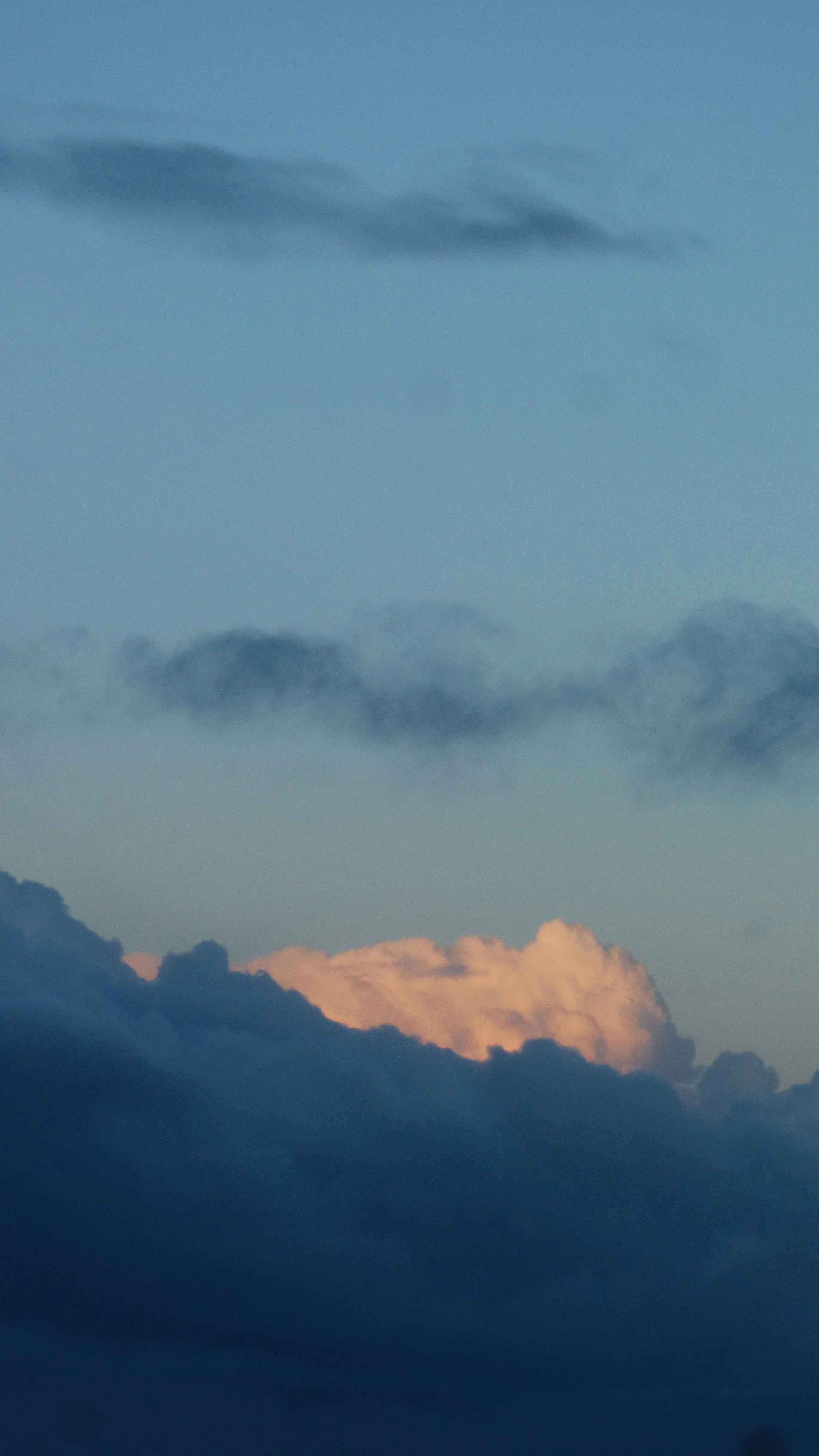 Soft Sunlit Clouds Above a Quiet Horizon