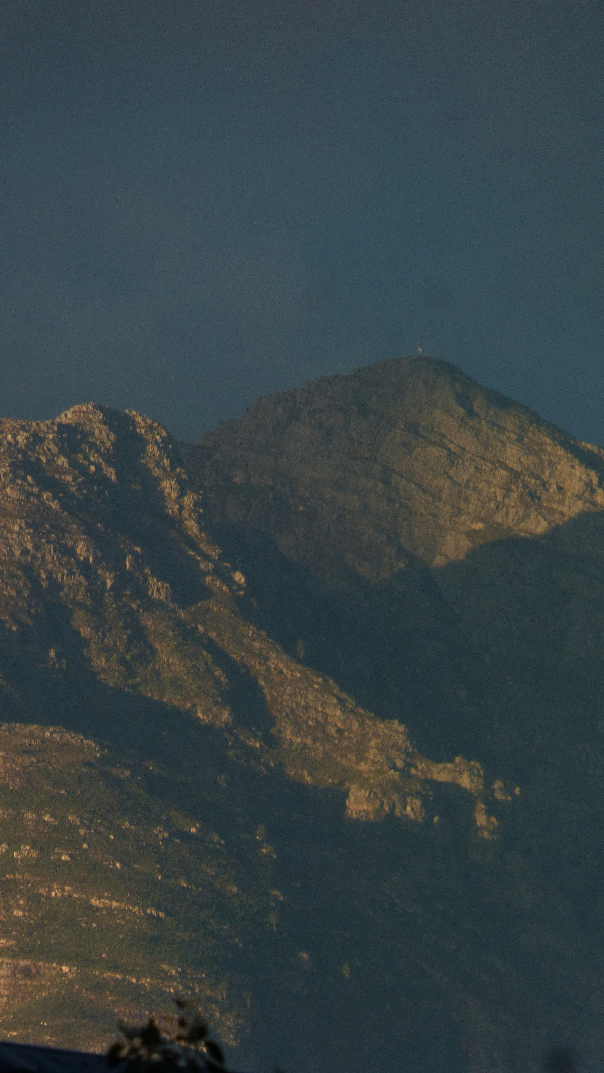 Sunlit Peak: A Lone Crest basking in Gloaming Light