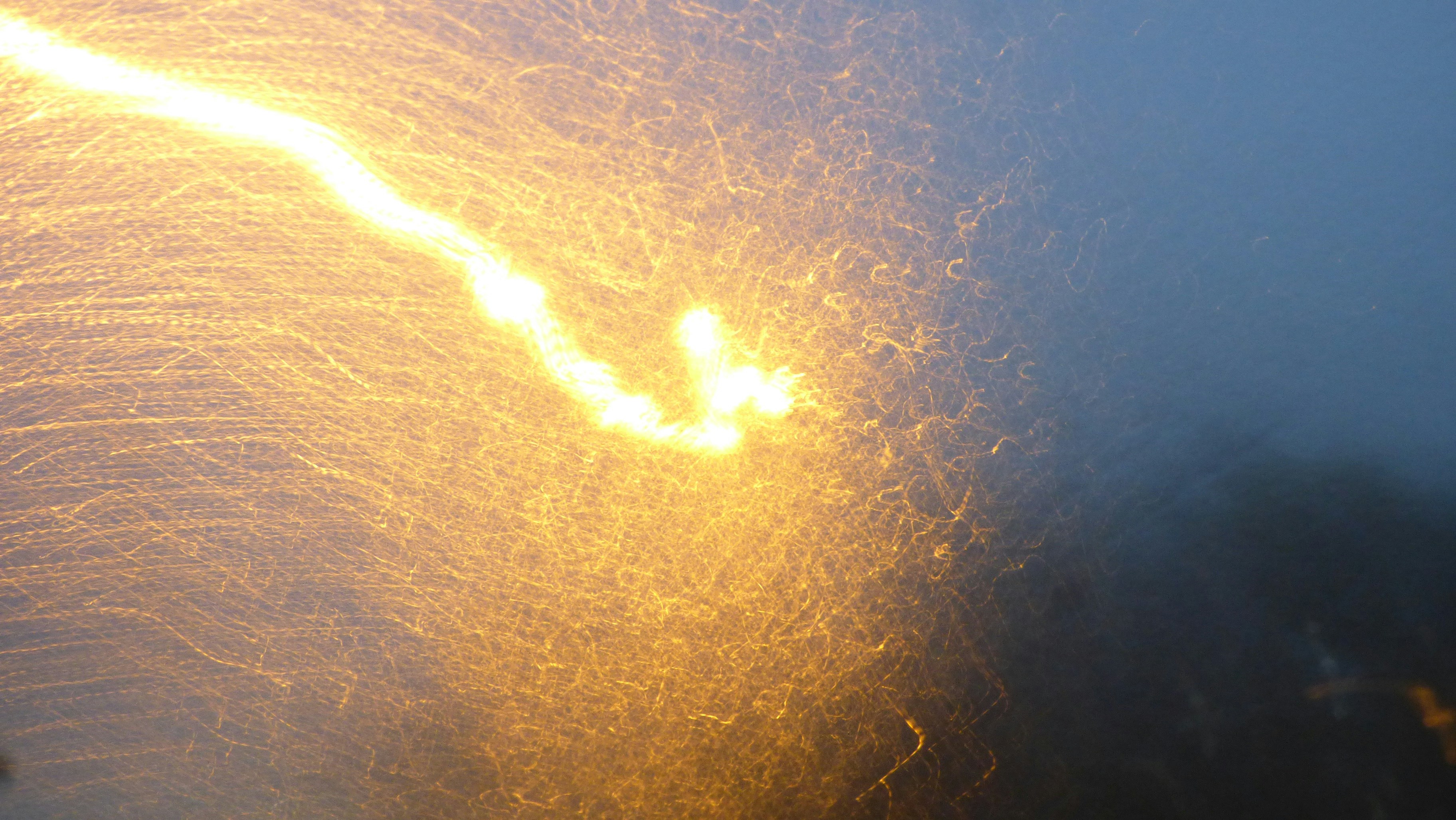 Golden Trace: A Spark in Turbulent Water