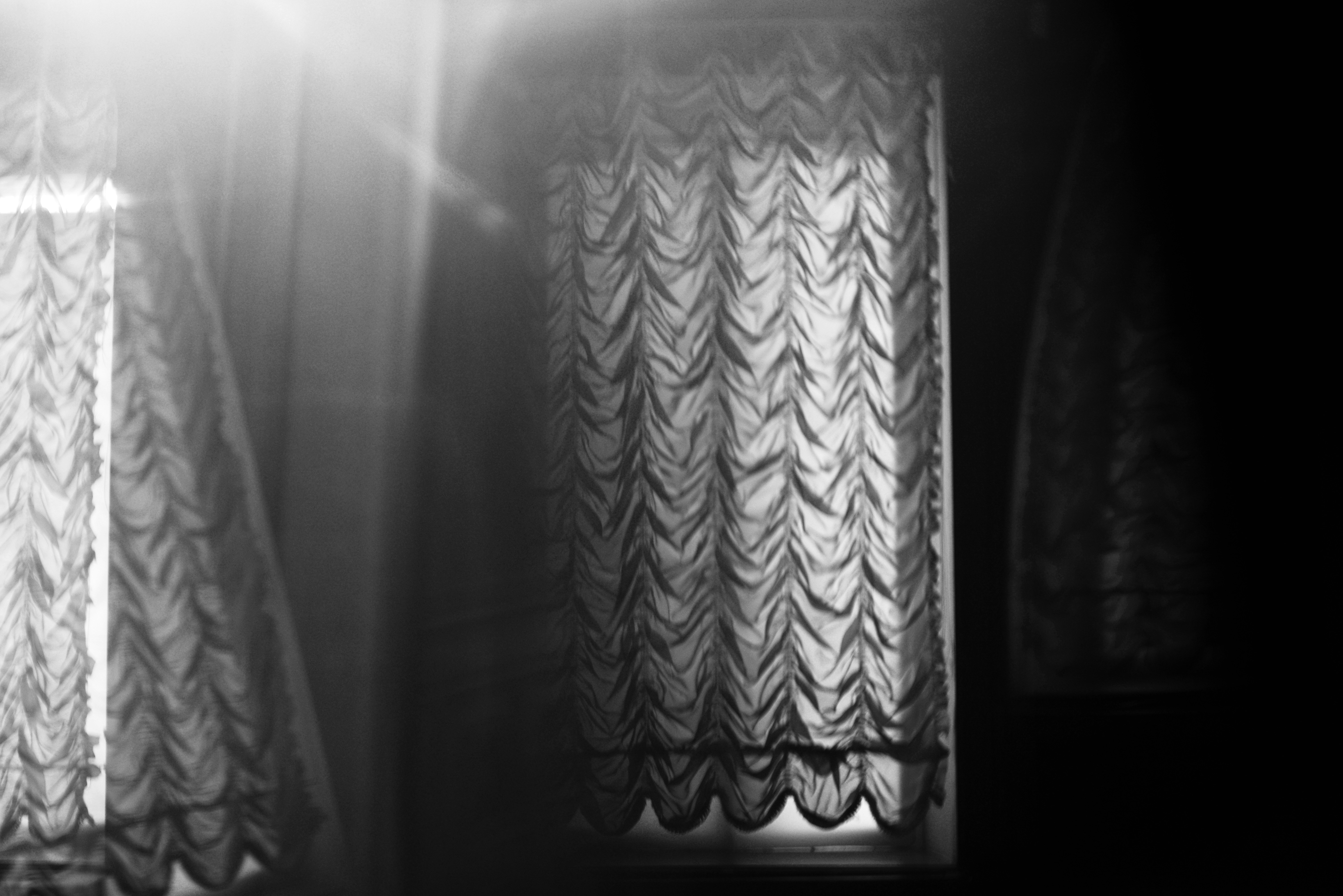 Light Through Veiled Drapes: A Quiet Window in Mono