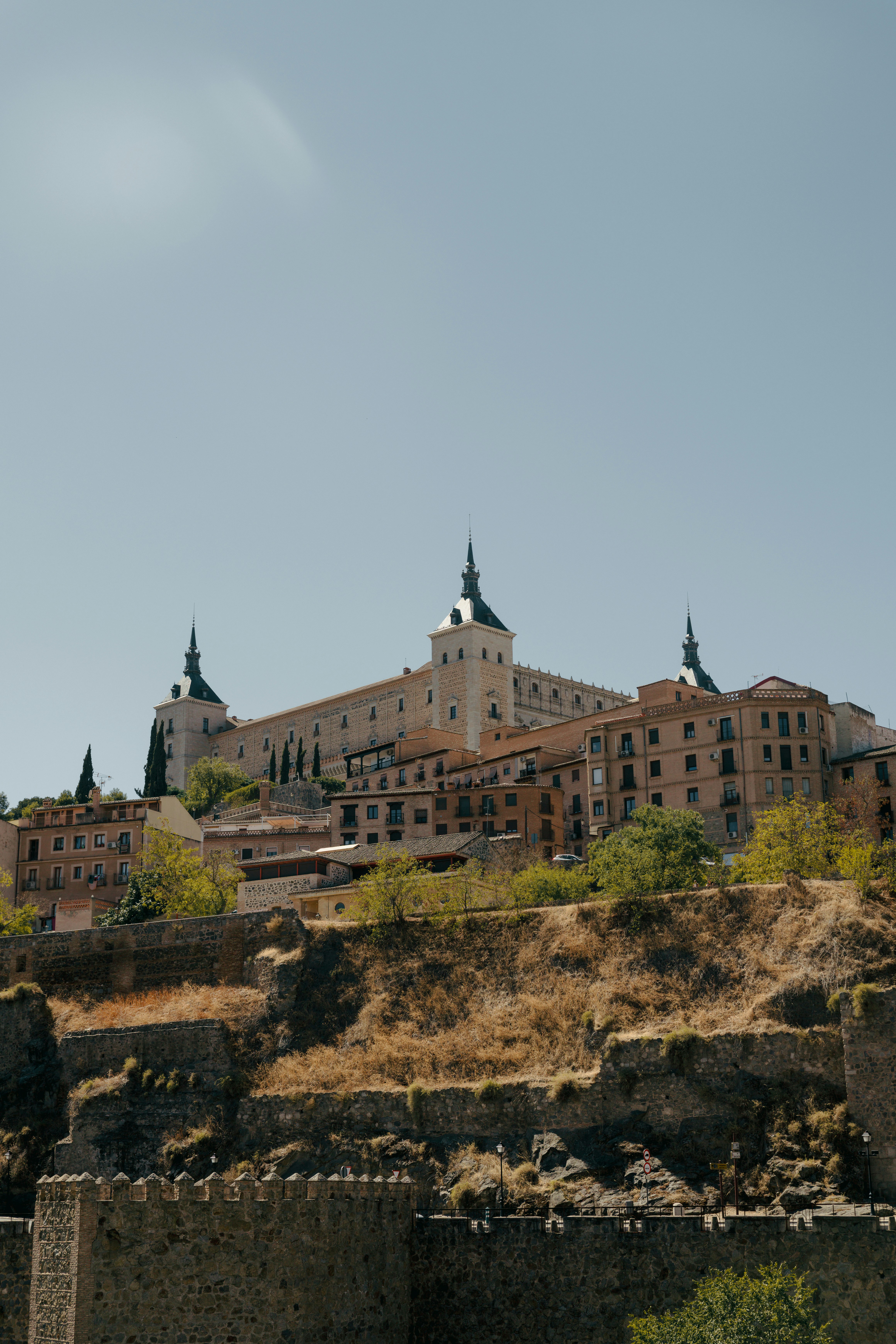 Castle on the Hill: A sunlit fortress overlooking rugged terraces