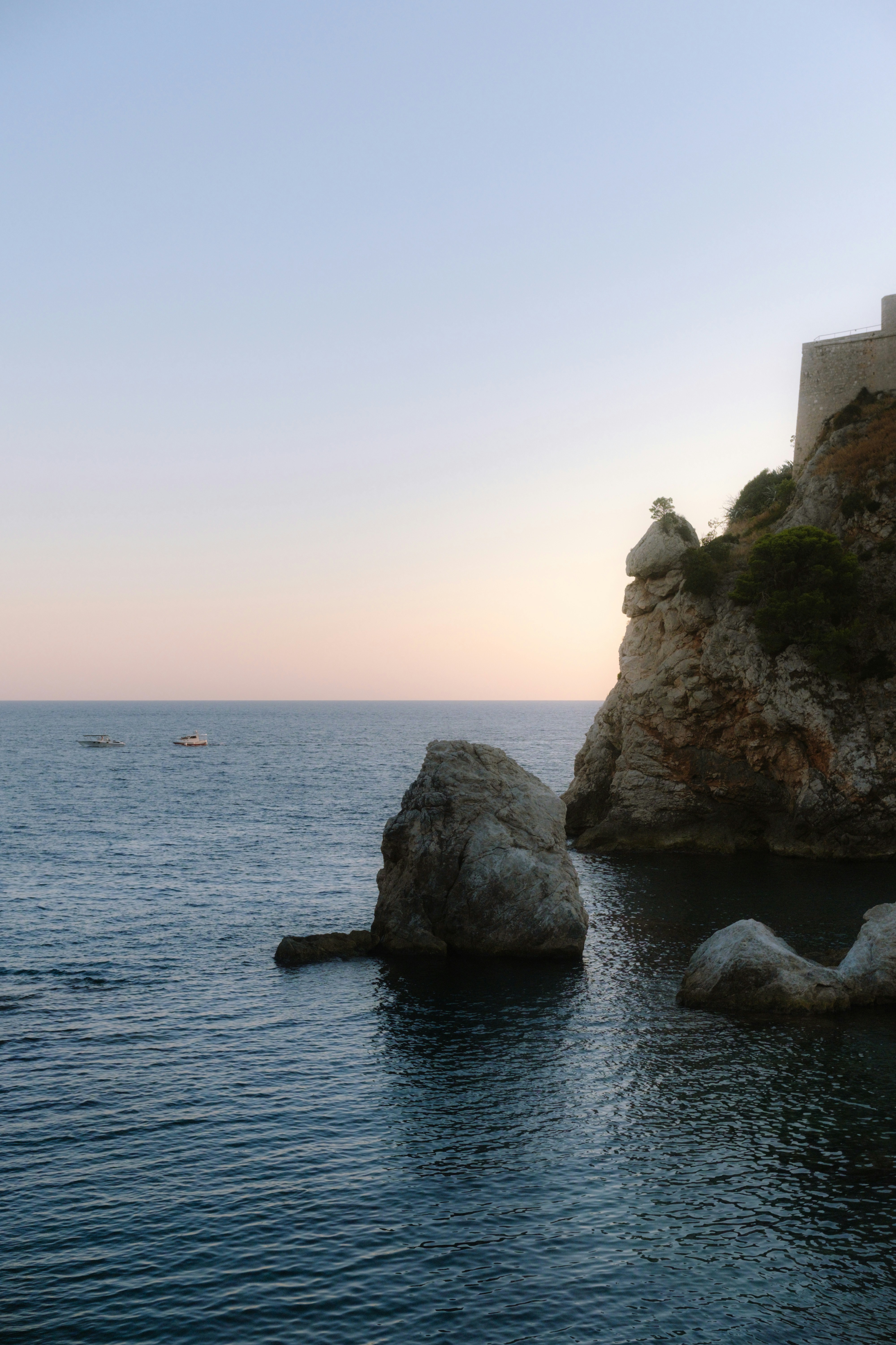 Cliffside Vista at Sunset Over Calm Seas