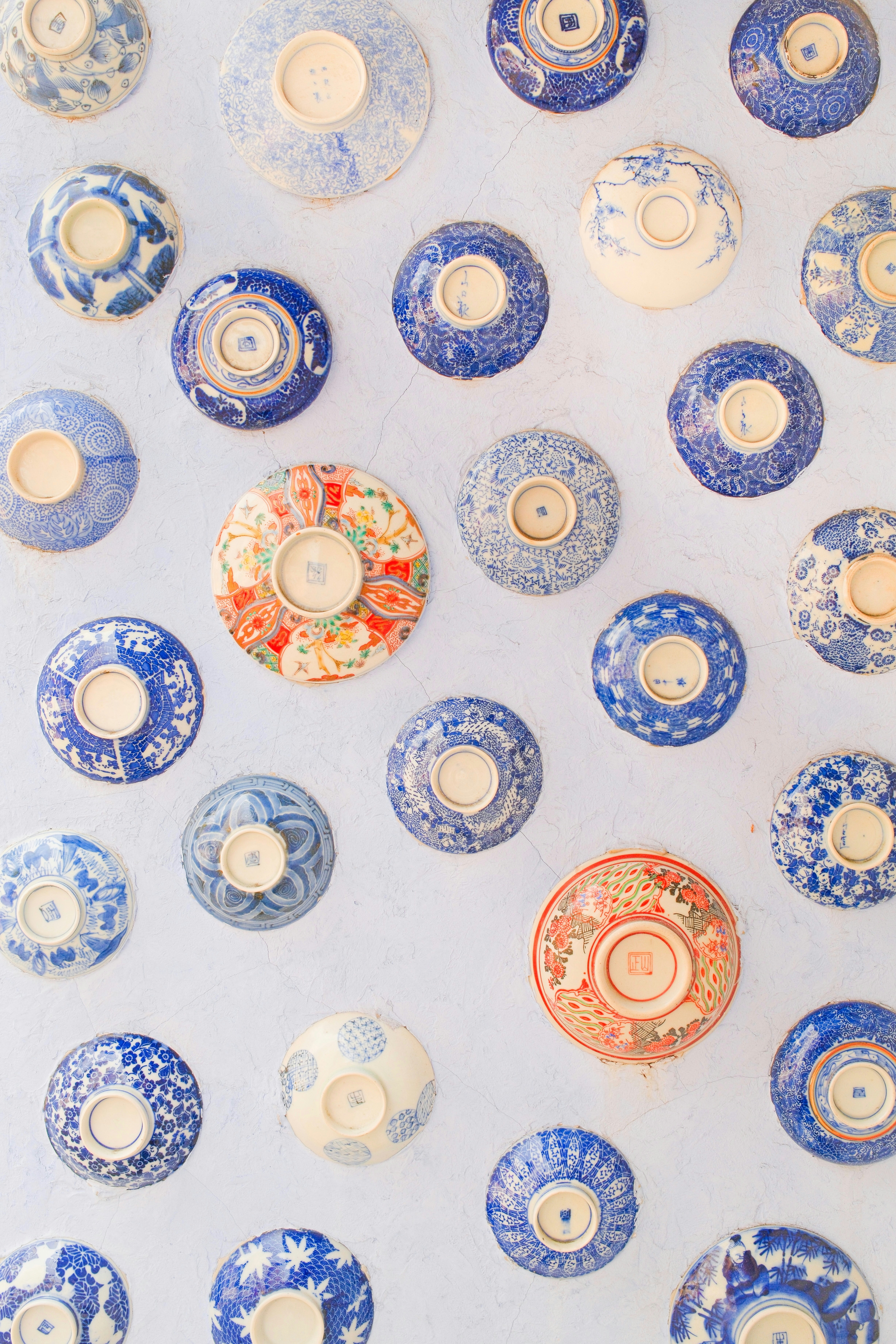 Ceramic Orbs: A Grid of Blue-and-White Vessels in Soft Light