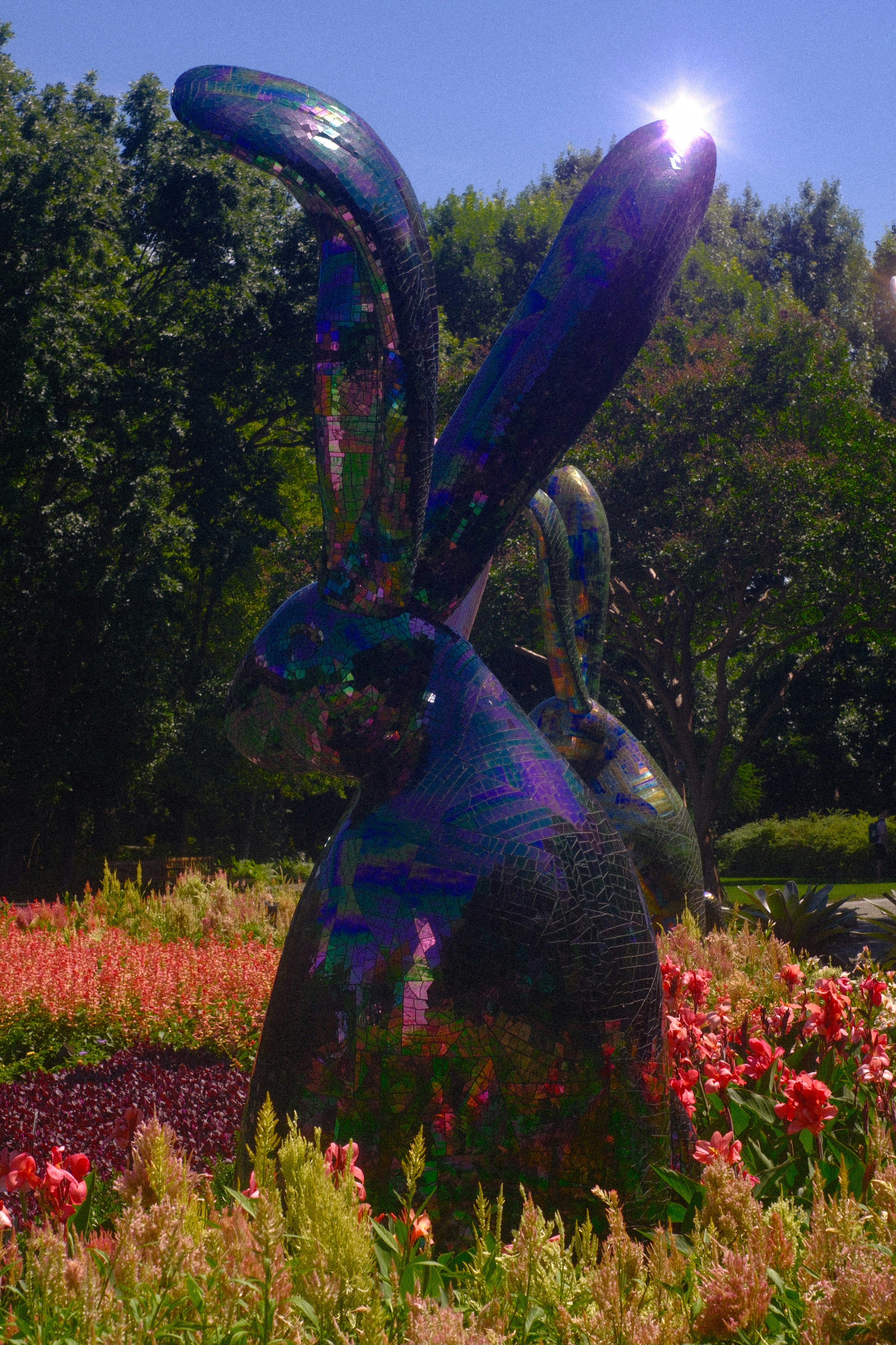 Sunlit Serpent Sculpture: A Prism of Color in the Garden