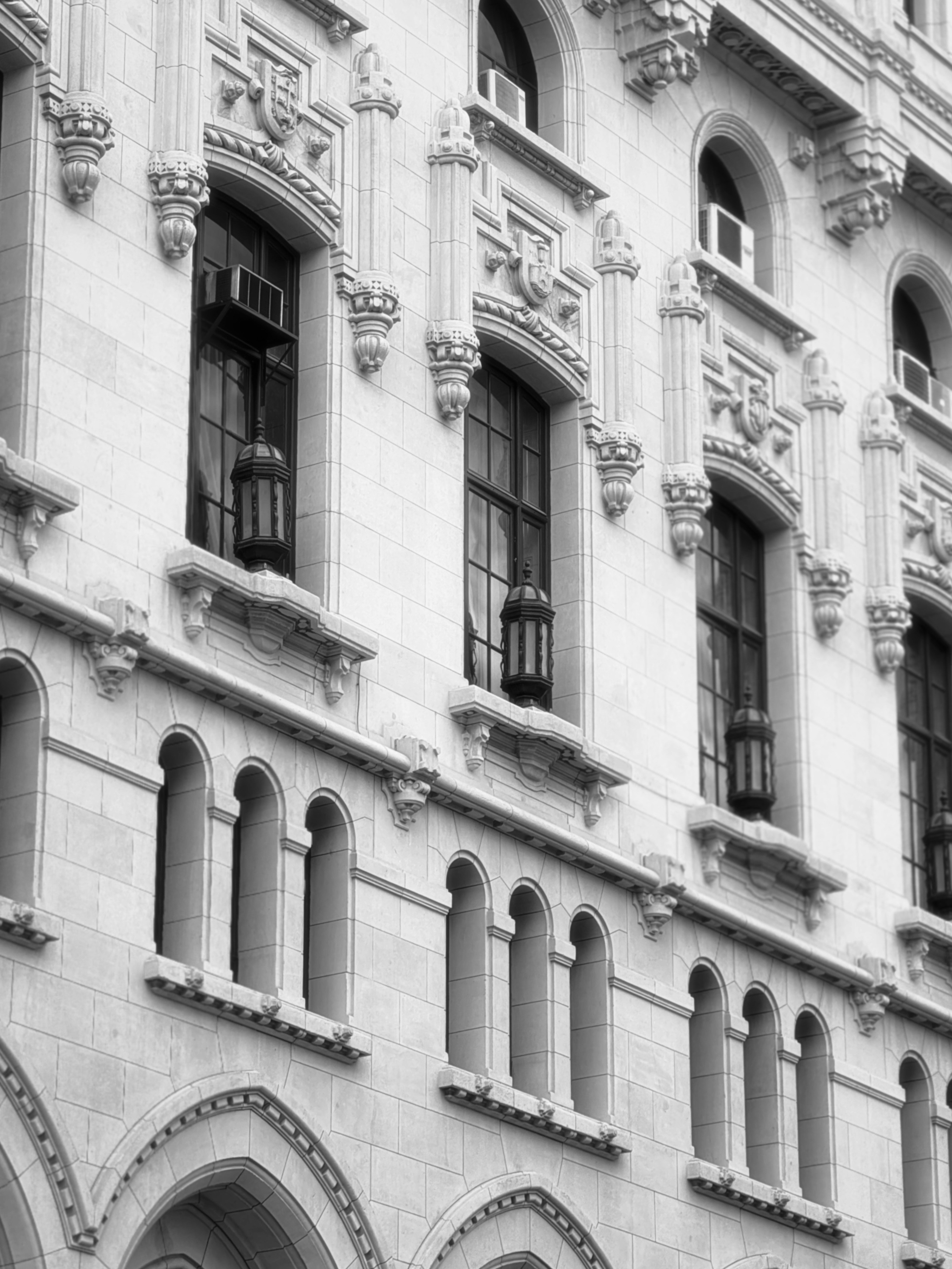 Ornate Facade in Monochrome: Arches and Lanterns in Stone
