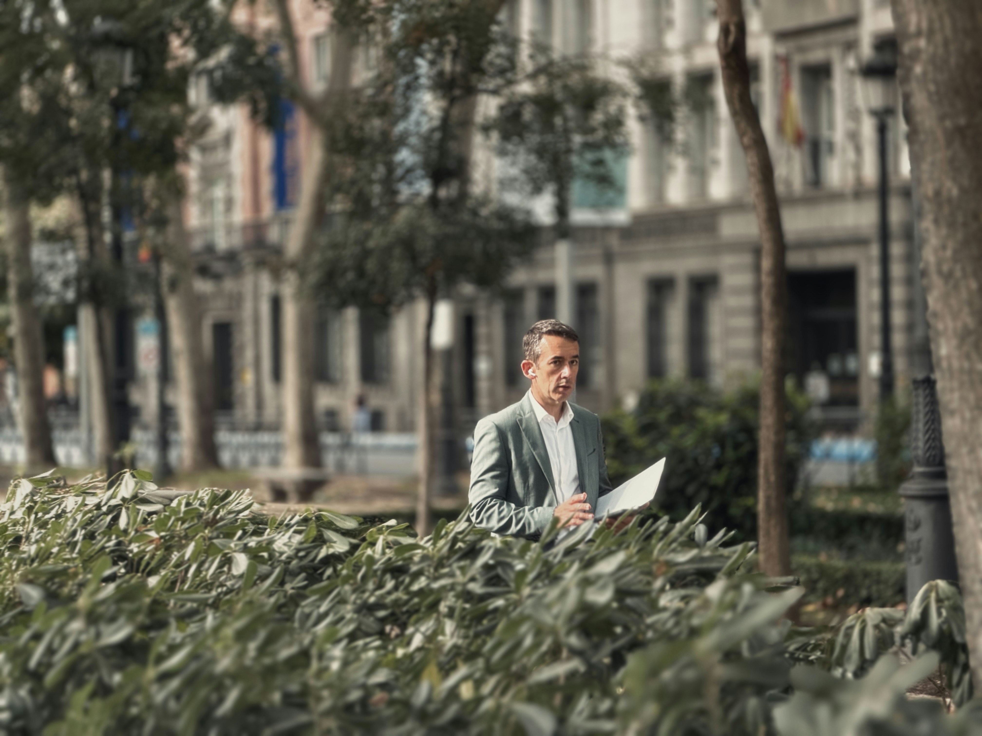 Urban Briefing: A Man Reads Quietly in a Parklike Street