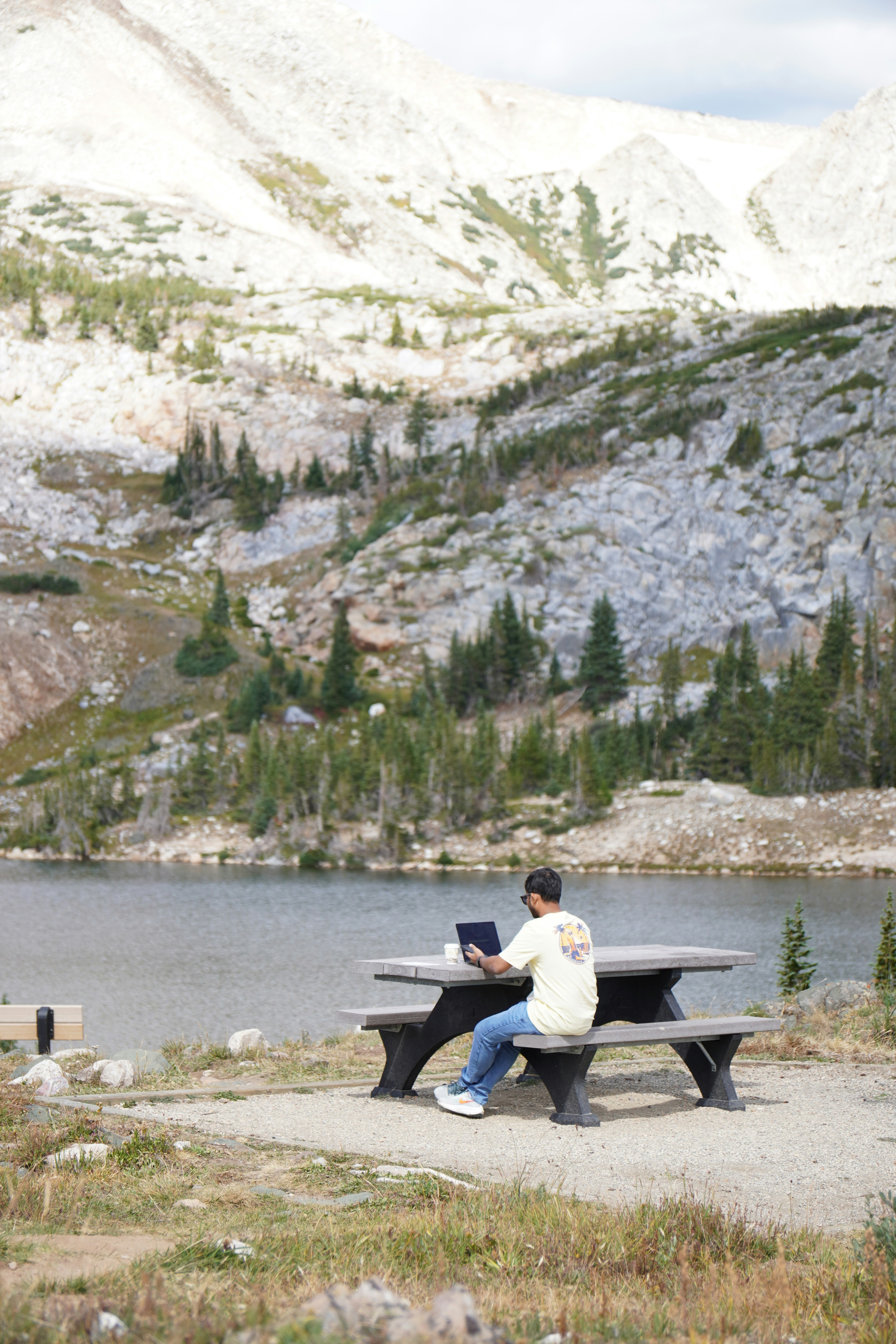 Lone Laptoper at the Lake: A Quiet Break by Rocky Pines