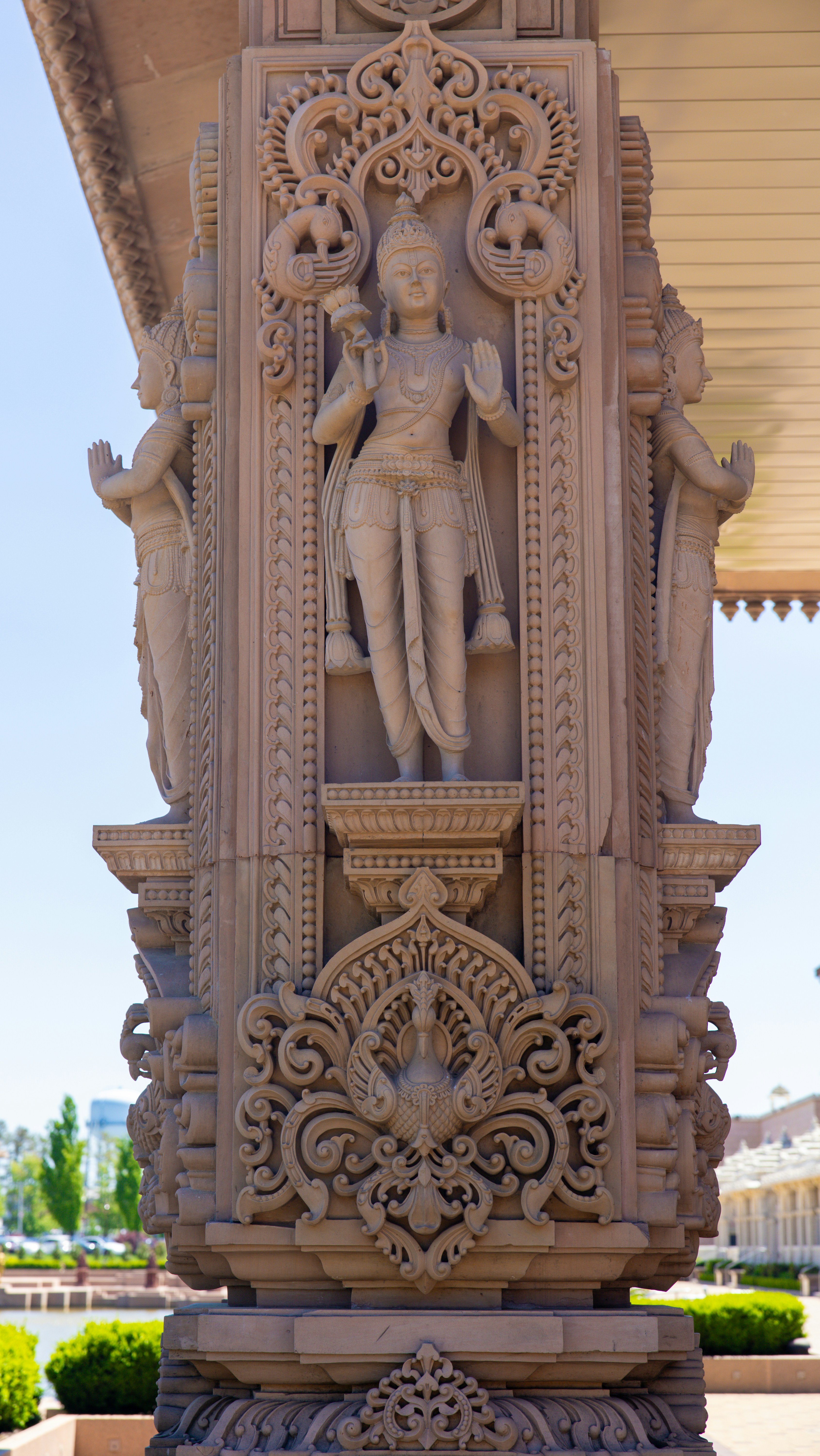 Stone Sentinel: A Carved Figura Standing Beneath Ornate Detail