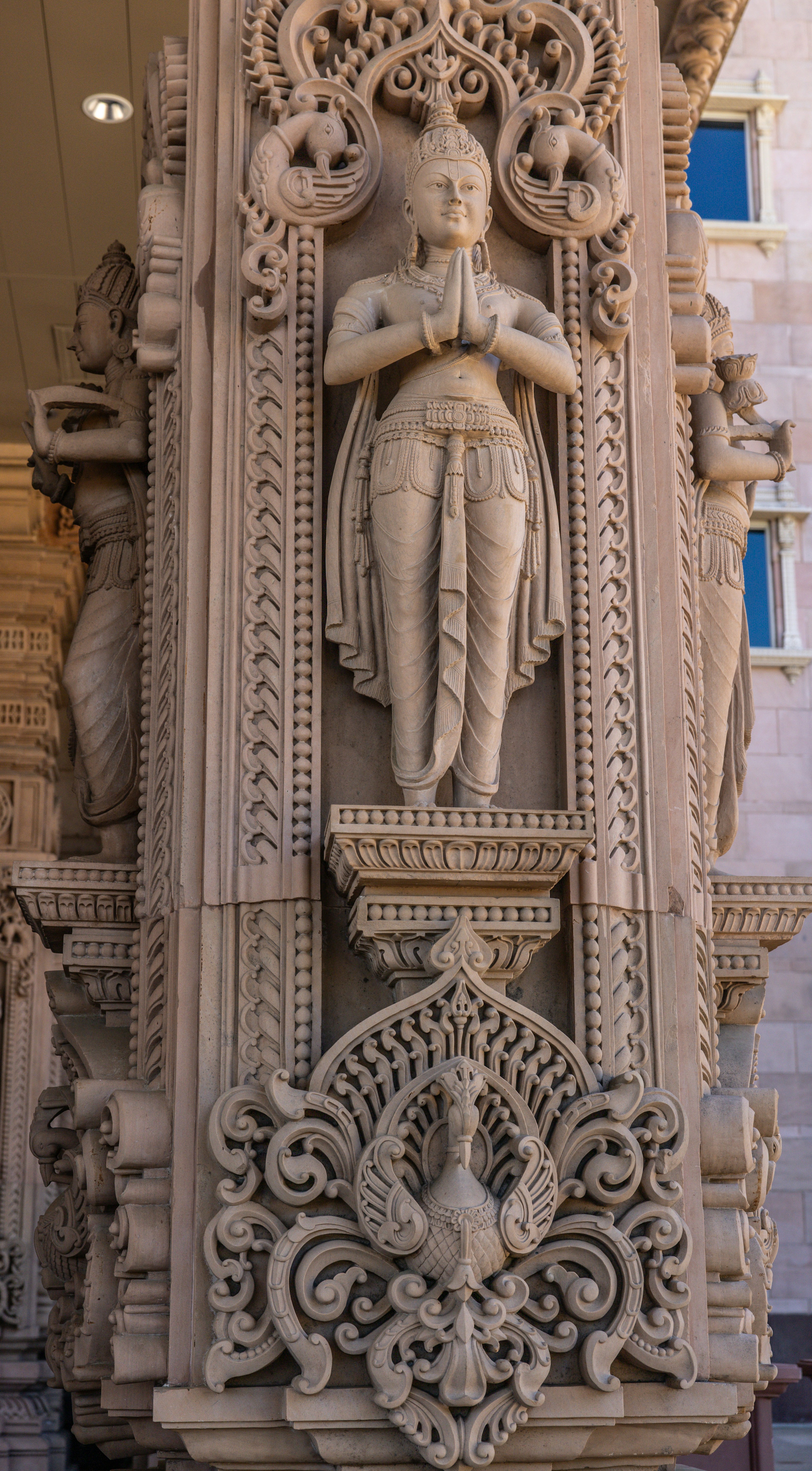 Stone Sentinel: A Sculpted Deity Adorns the Framed Façade