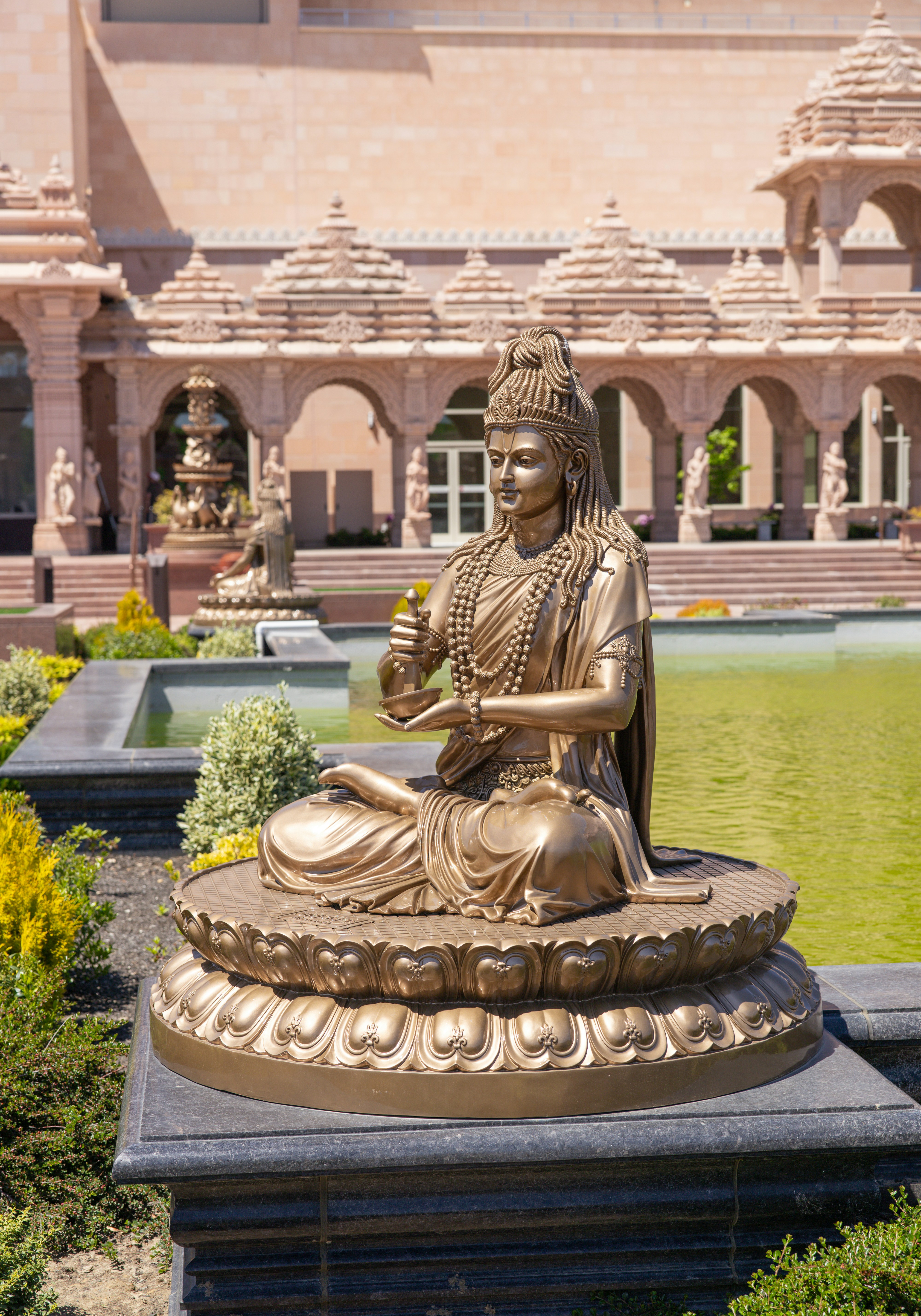 Bronze Serenity: A Meditative Goddess Guarded by Quiet Water