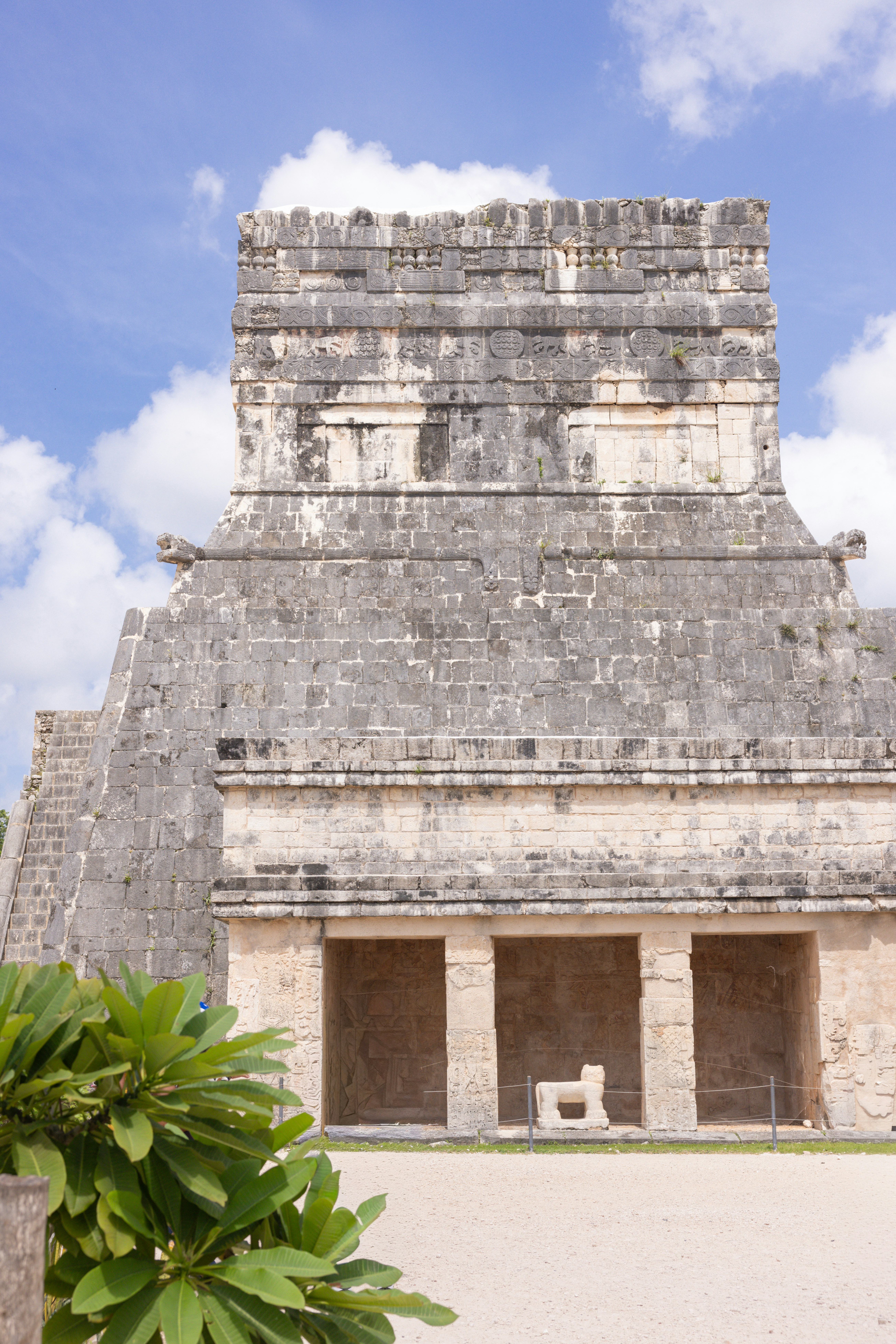 Kukulkan’s Shadow: Sunlit Pyramid Framed by Deserted Courtyard