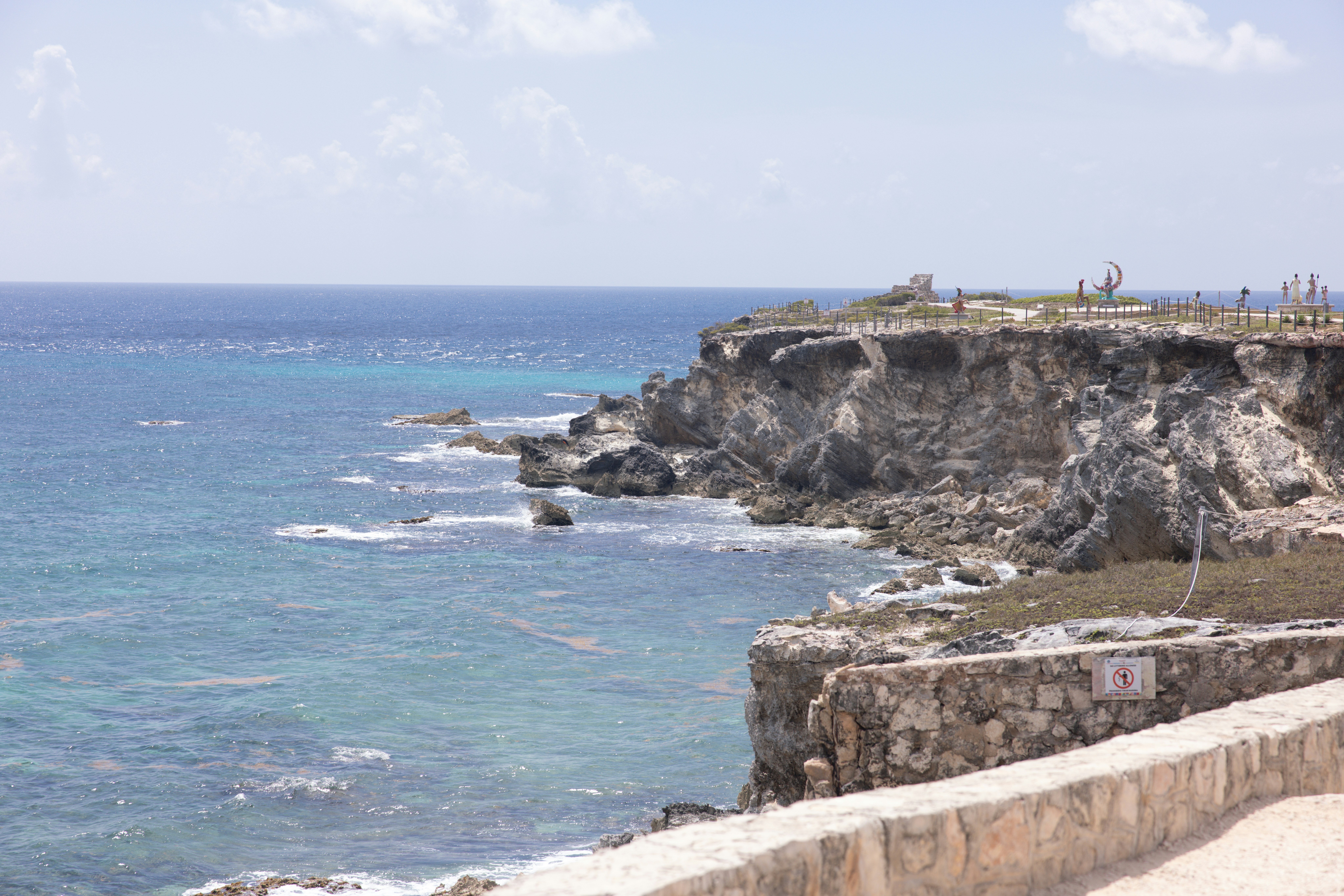 Cliffside Ocean Walk: A Sunlit Vista Over Turquoise Seas