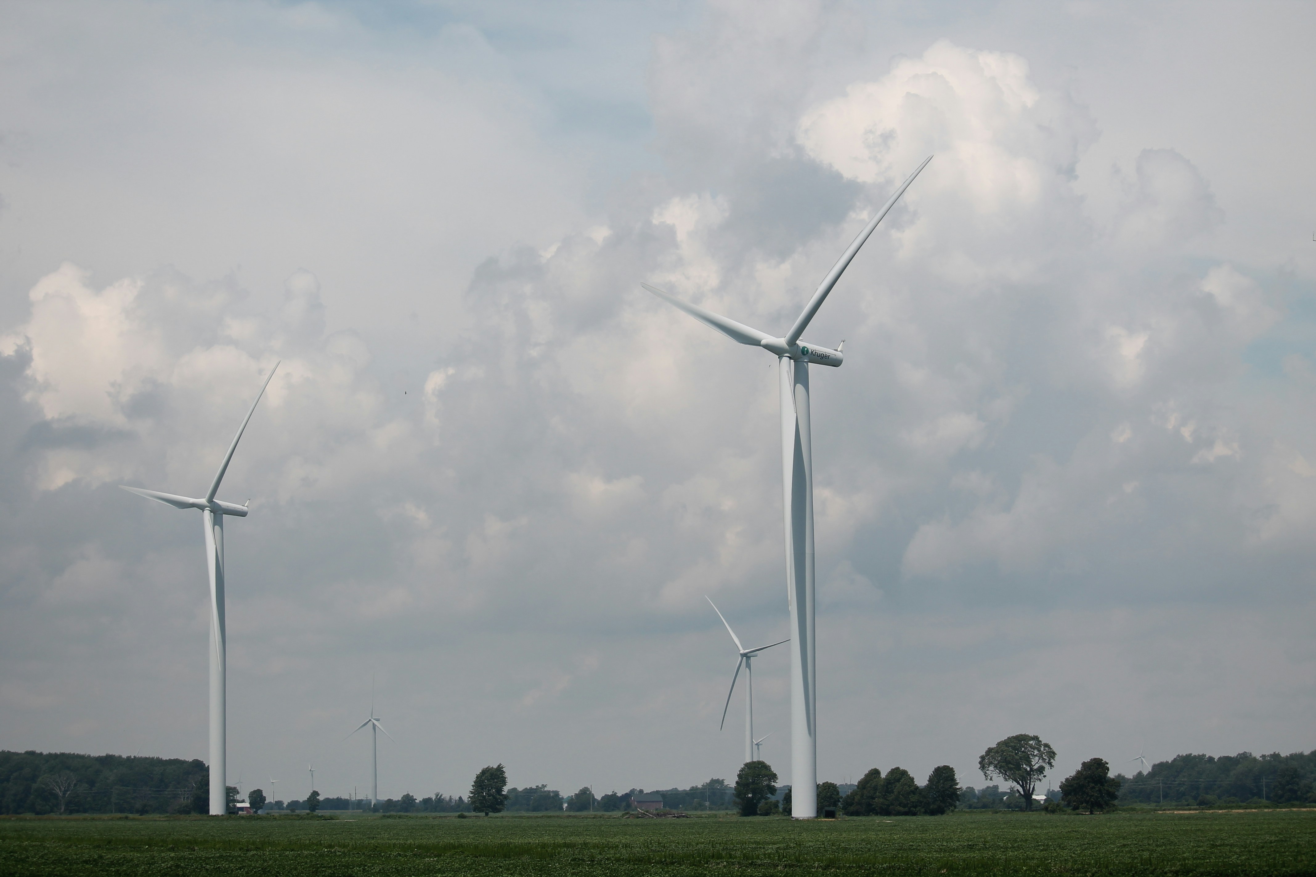 Verdant Plains and Majestic Turbines under an Expansive Sky