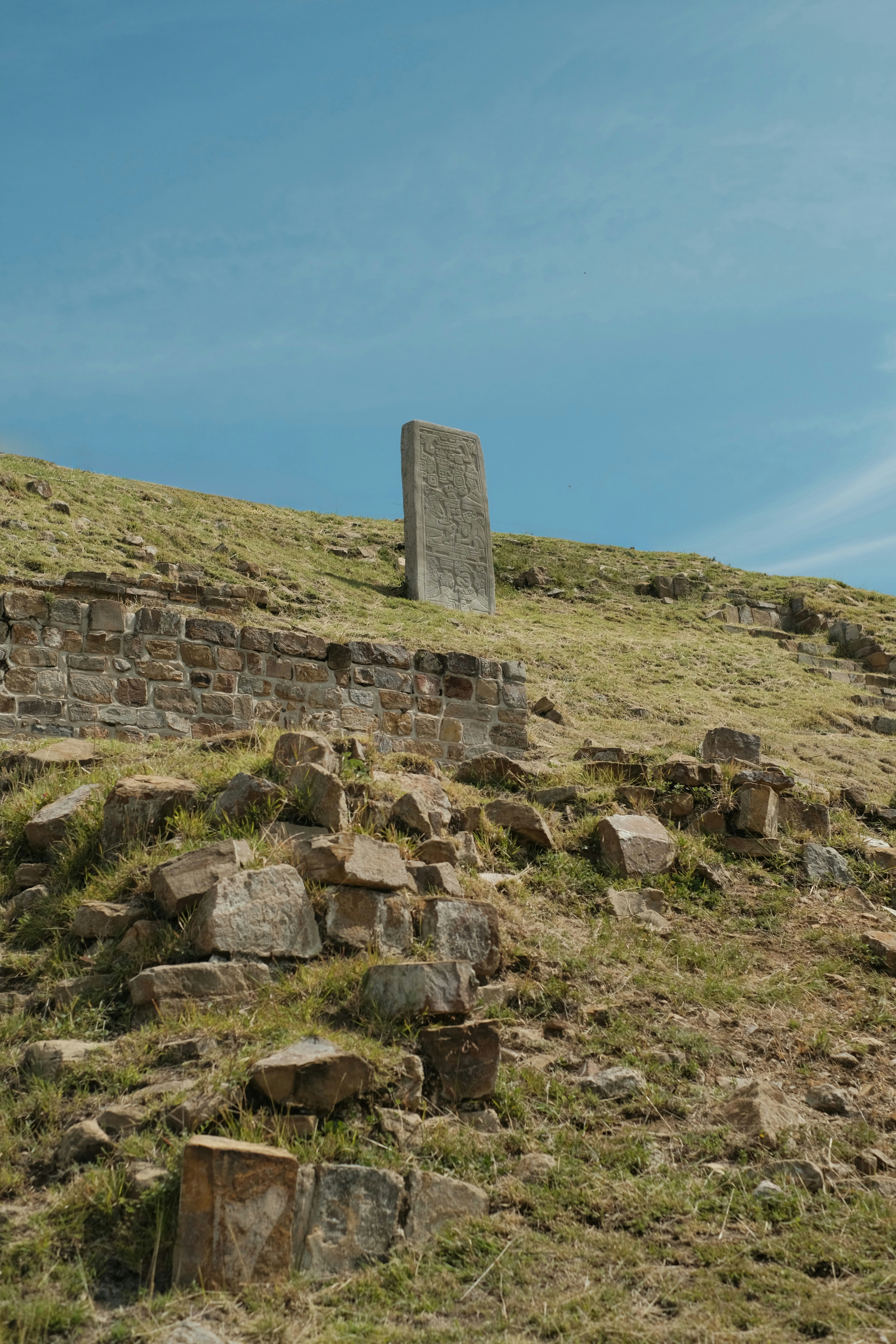 Standing Stone: A Lone Monolith Among Ancient Terraces
