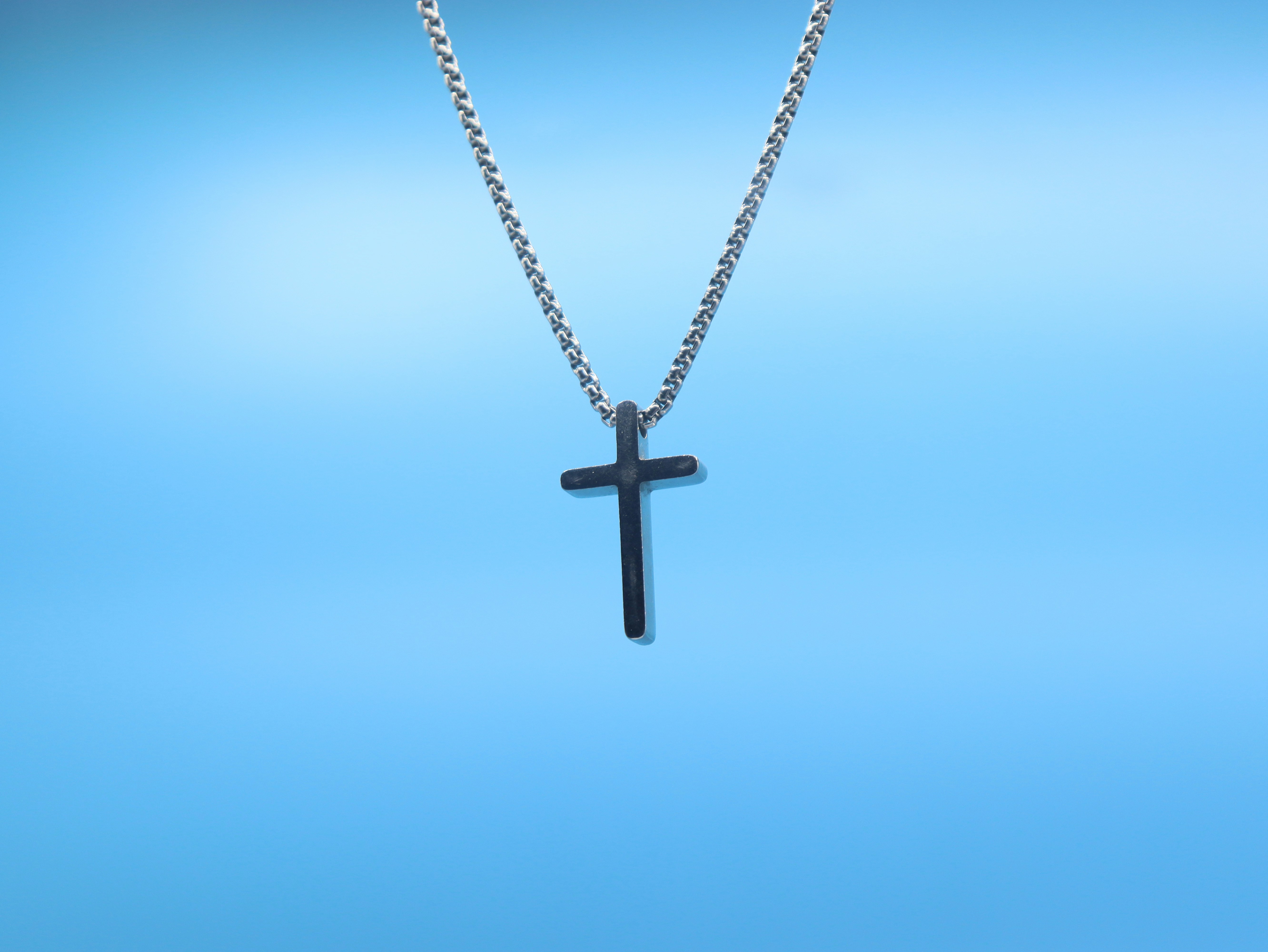 Pendant in Subtle Focus: A Prayerful Drop Against Blue Silence