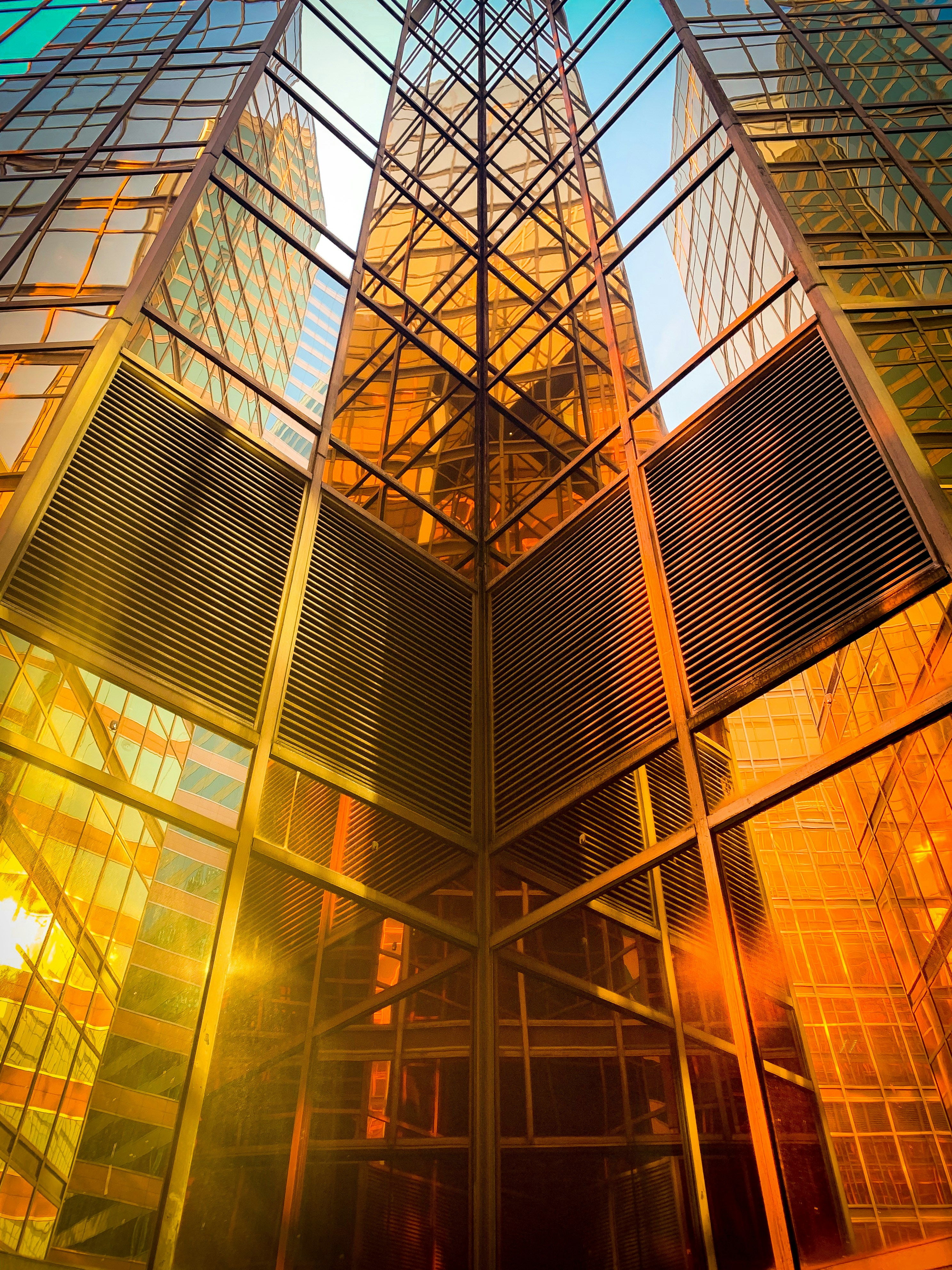 Tessellated Rise: Glass Facades Converge in Sunlit Geometry