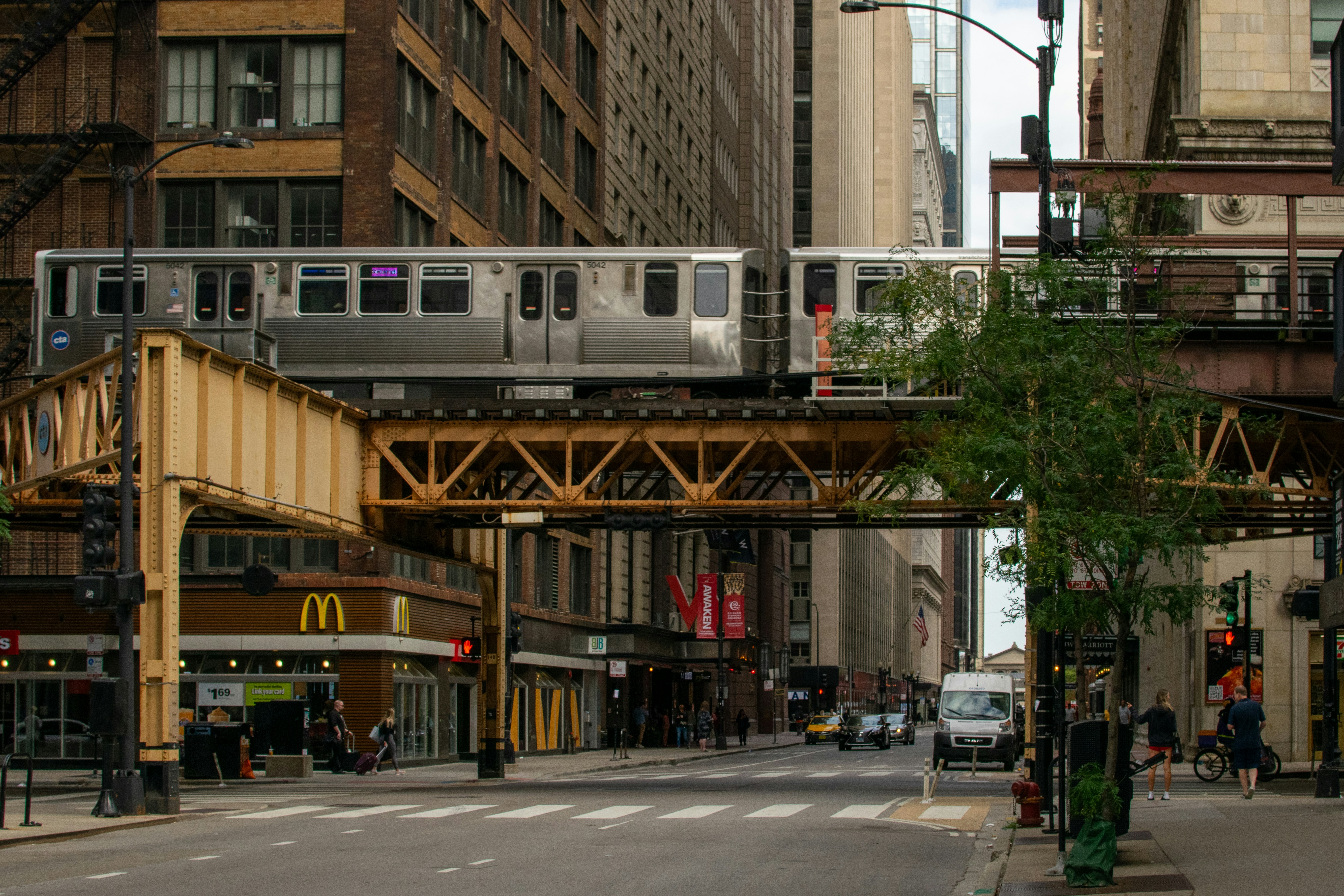 Urban Transit Above: A Train Streaks Over a City Street Crossing