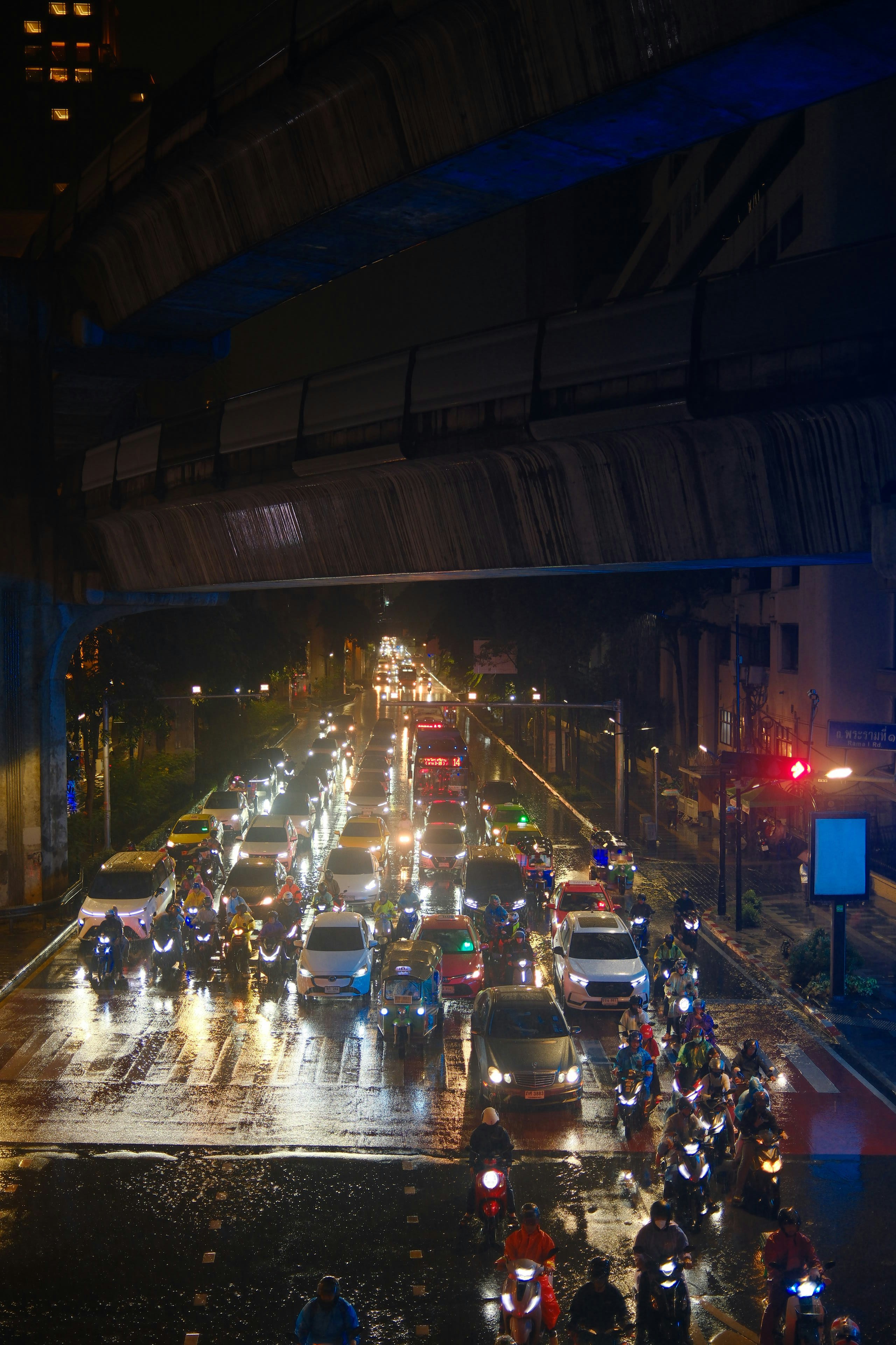 Neon River of Traffic Under the City Overpass