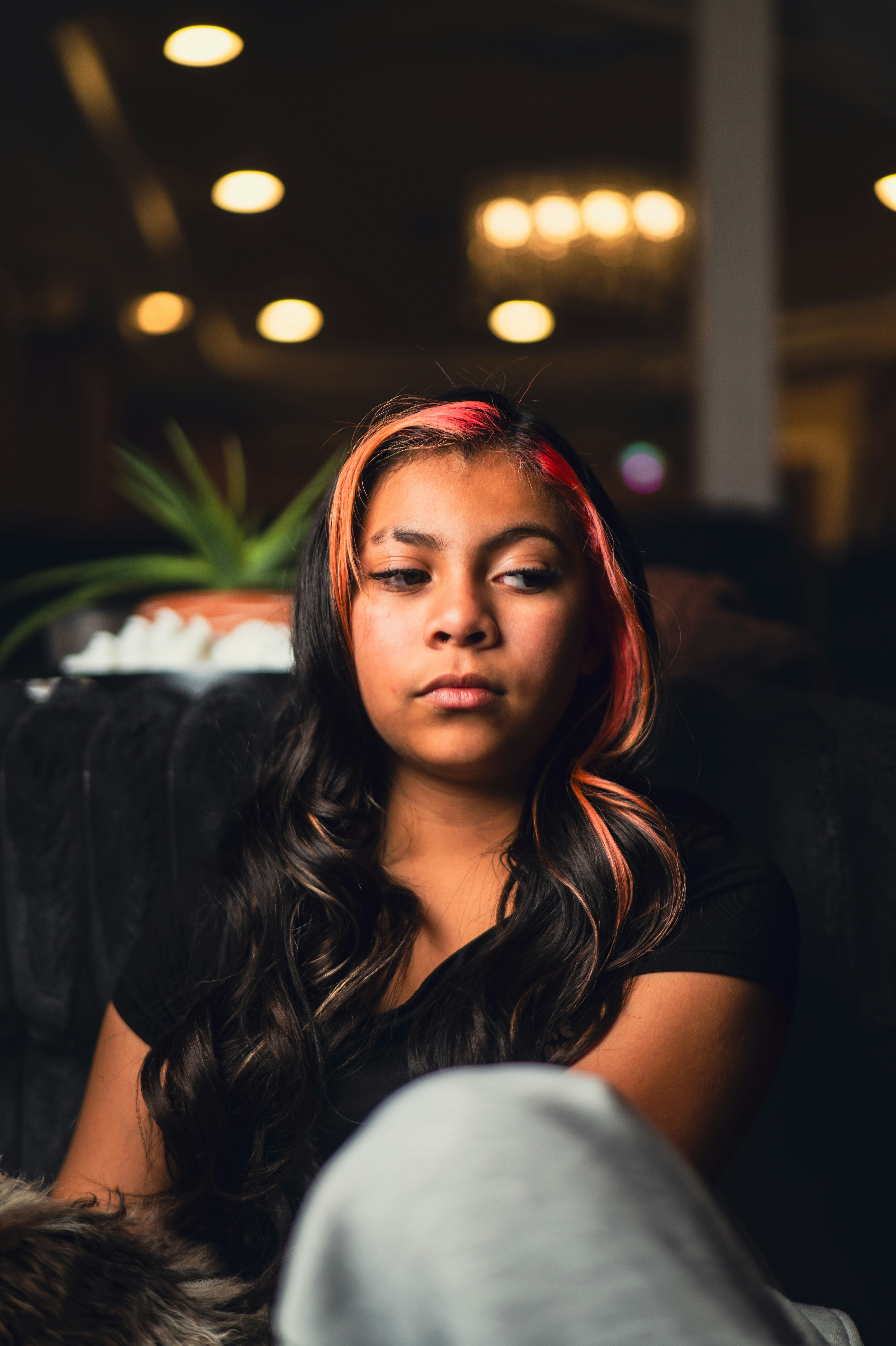 Soft-Glow Portrait of a Woman with Colored Hair in a Cozy Lounge
