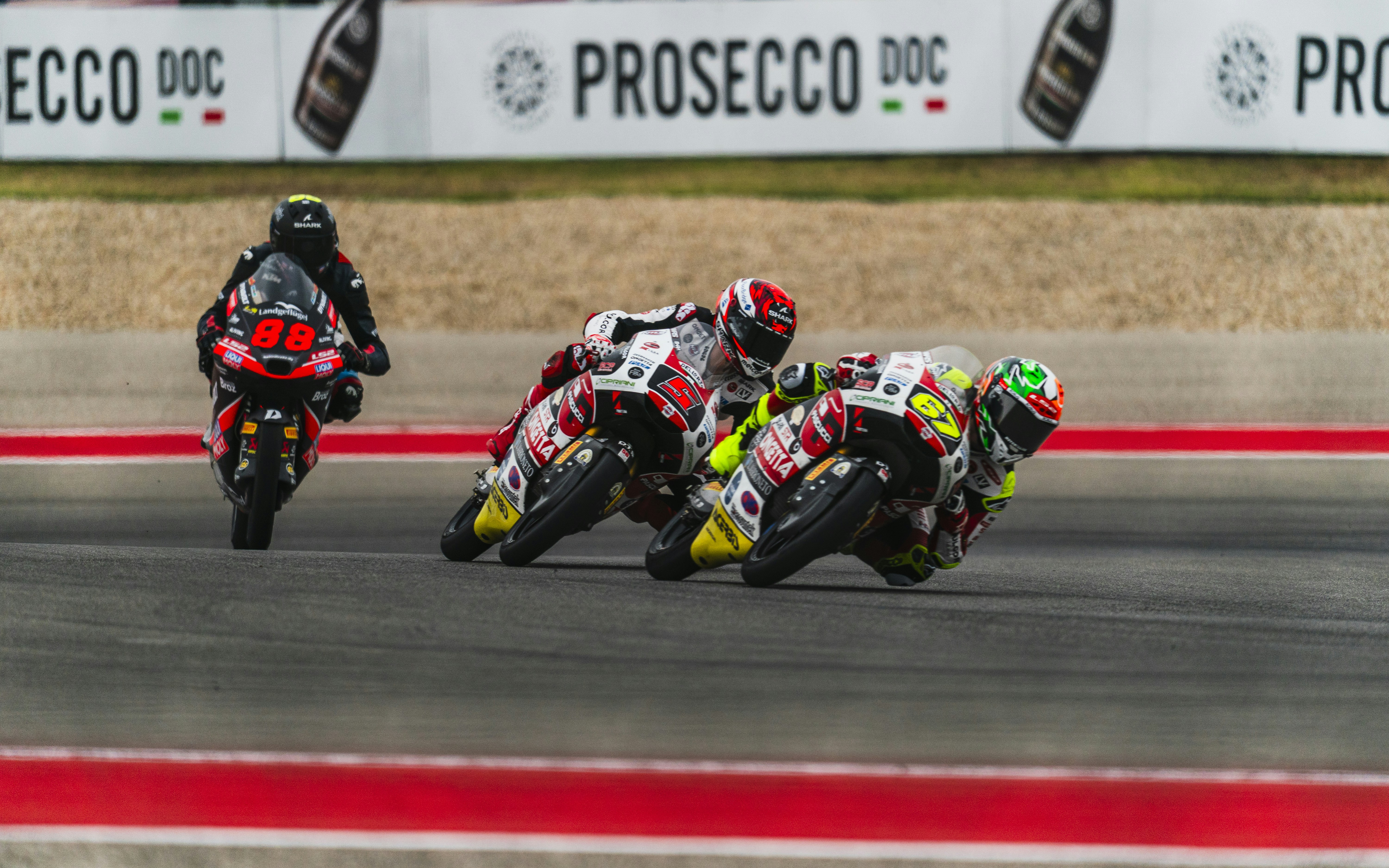 Triad of Velocity: Cornering Riders in a Prosecco Arena